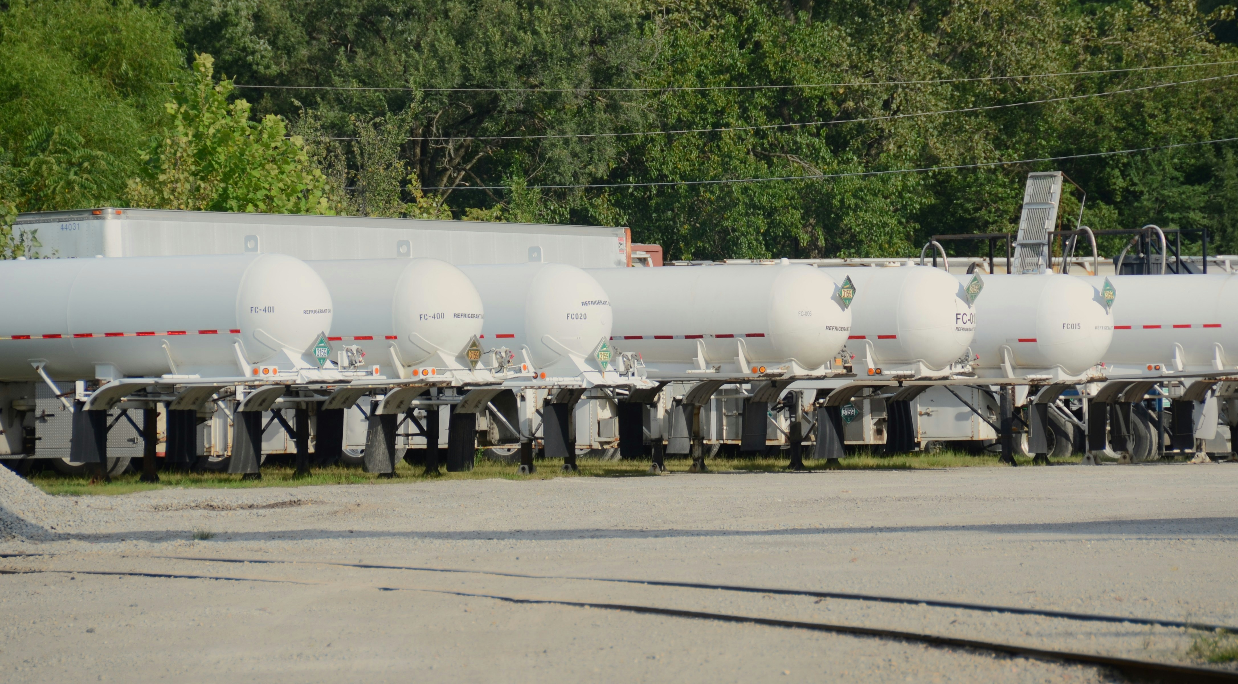 Line of Hovering Giants: Fuel Tankers Resting on Rails