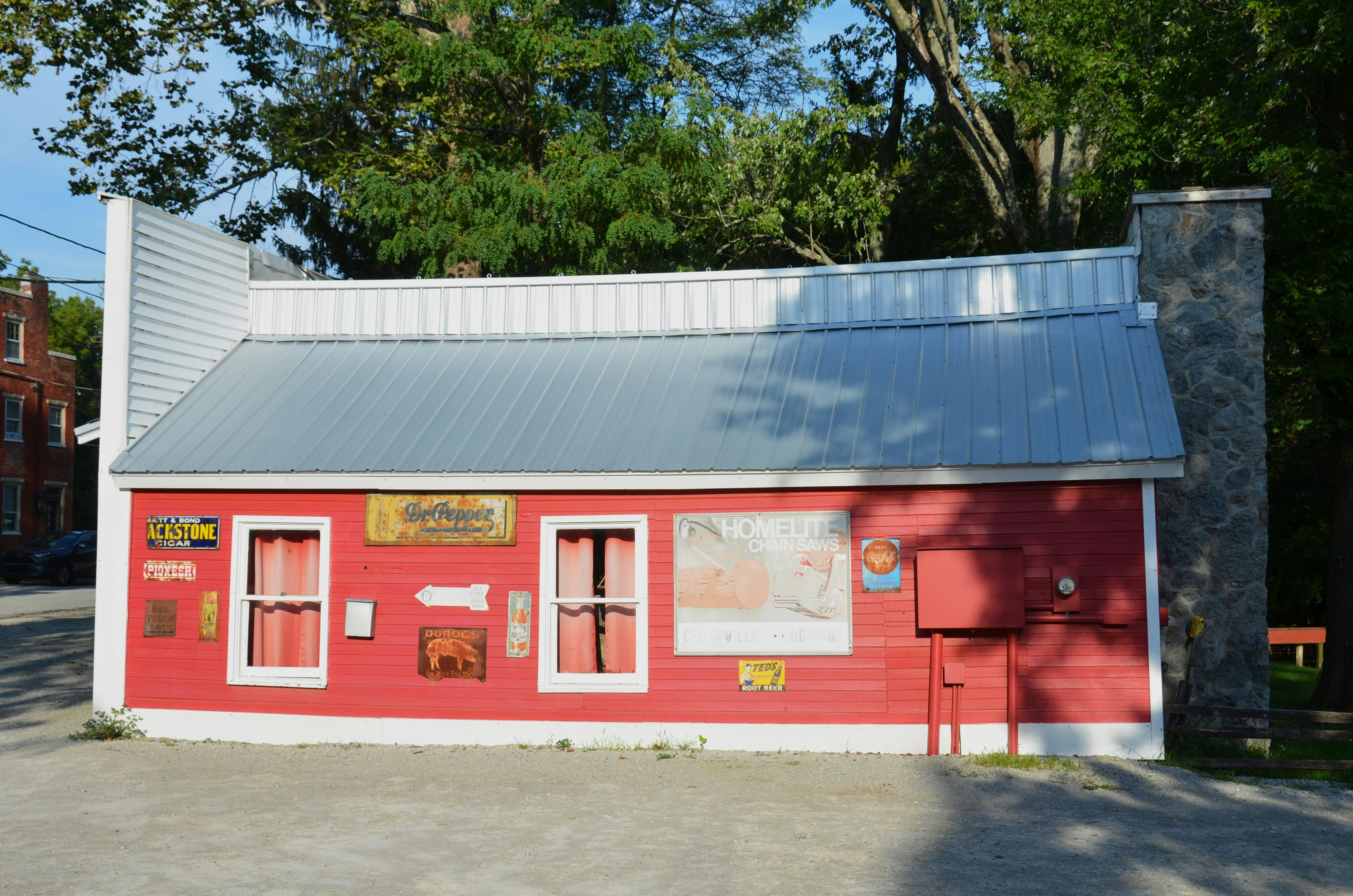Red storefront house with metal roof and vintage signage