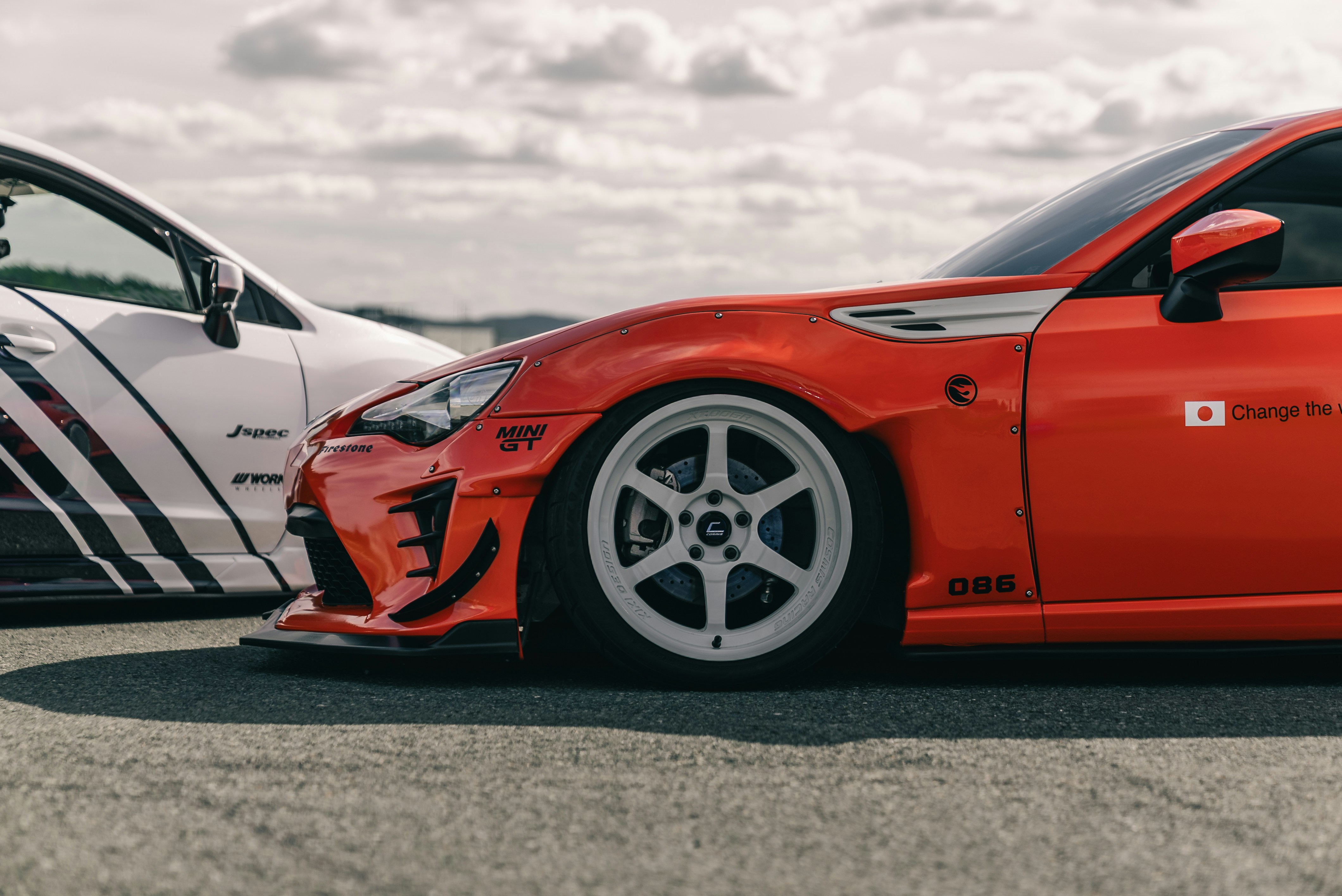 Two Sports Cars Face Off: A Close-Up of Red Precision Stance