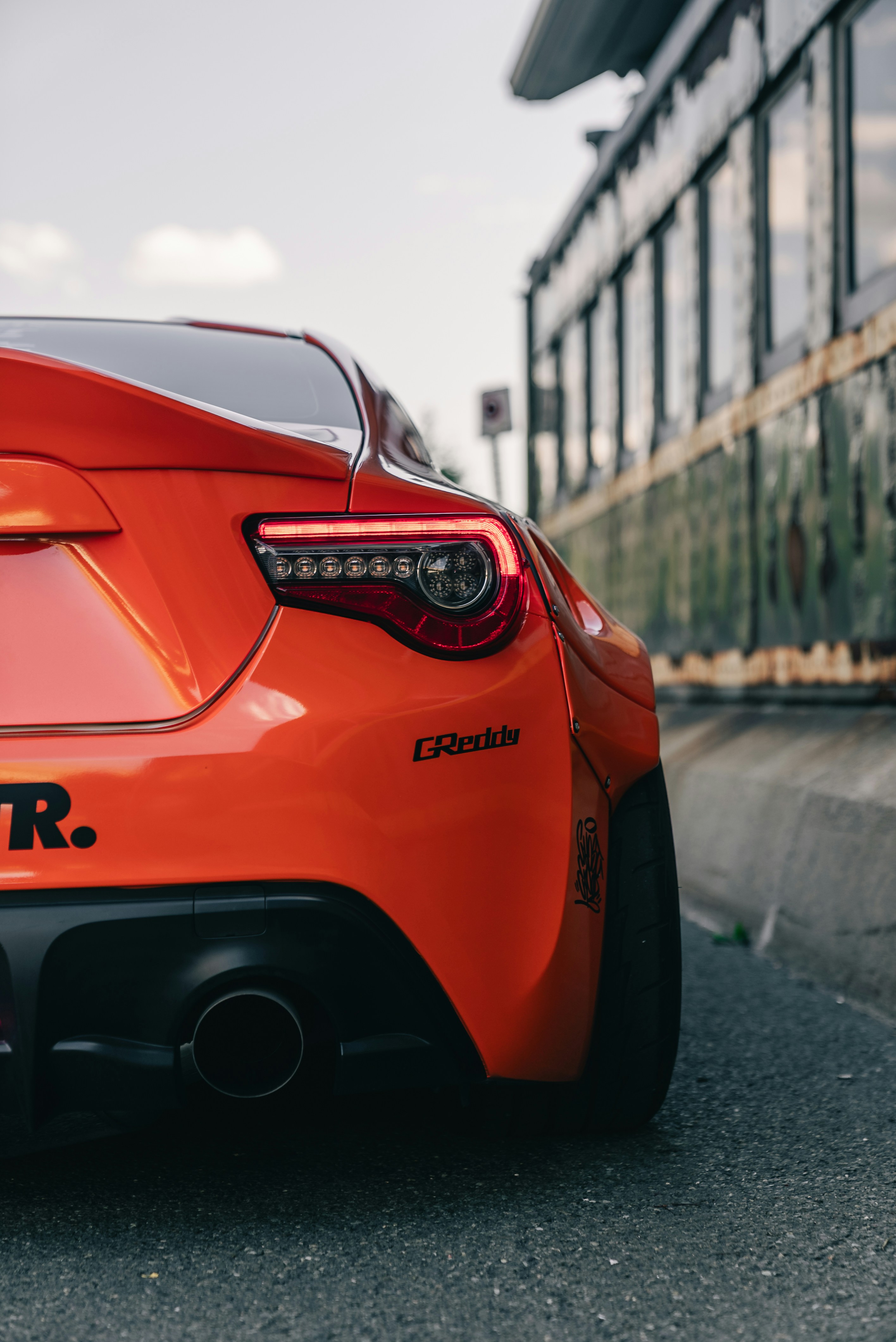 Orange Power, Tight Curve: The Rear Corner of a Track-Ready GT