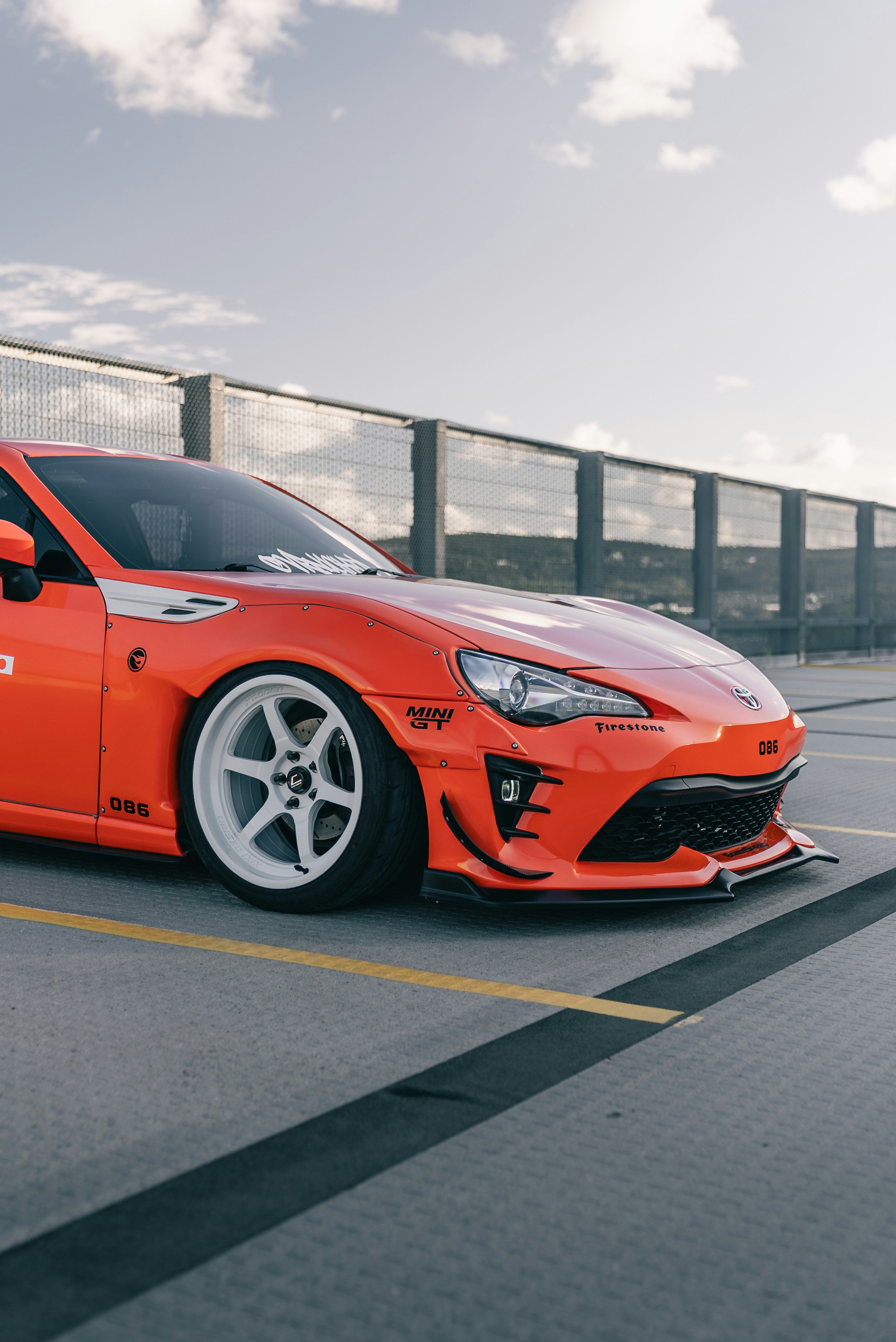 Racing Orange: A Low-Angle Stare at a Tuned Toyota