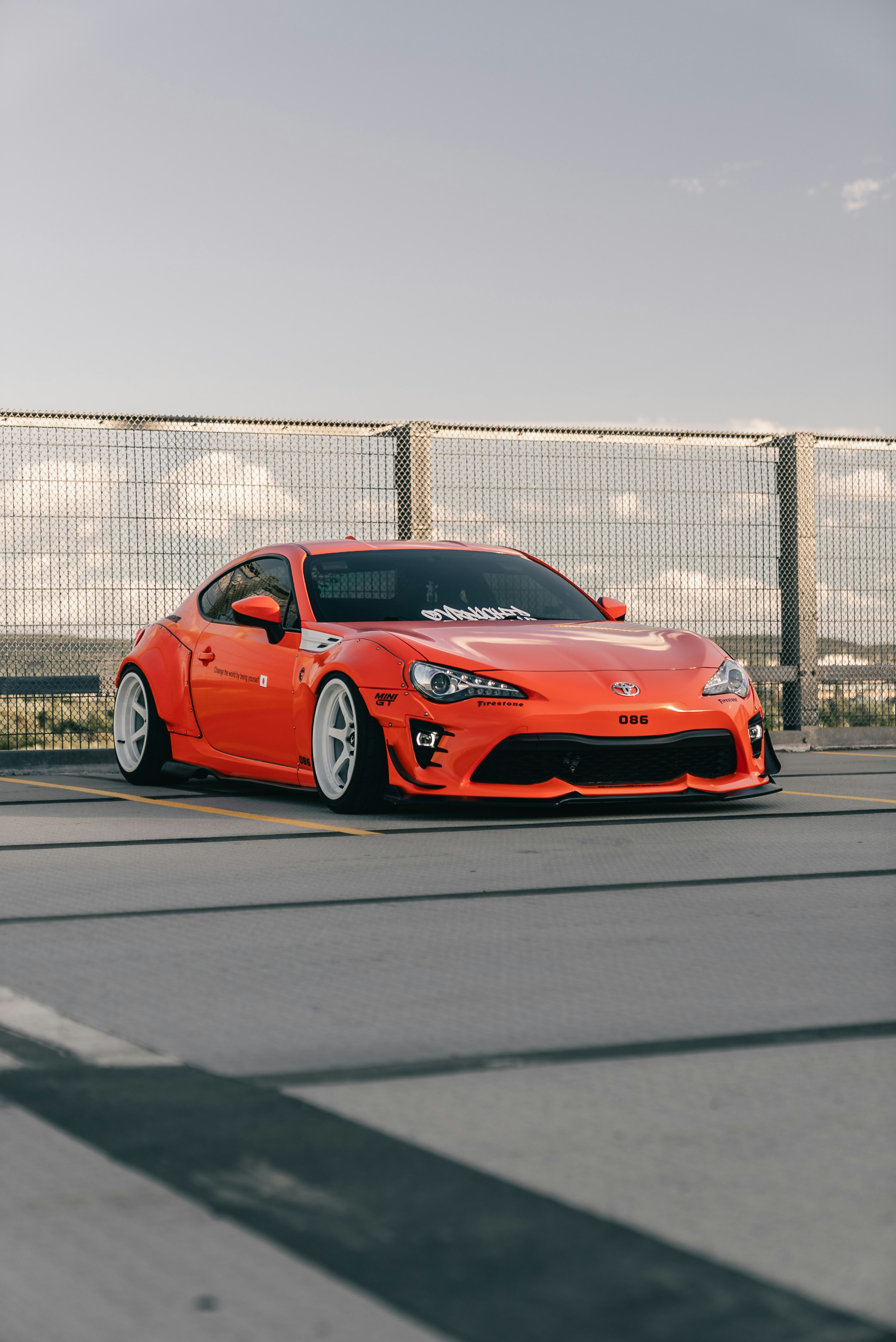 Orange Drift King: A Low-Rlung Car at the Edge of the Sky
