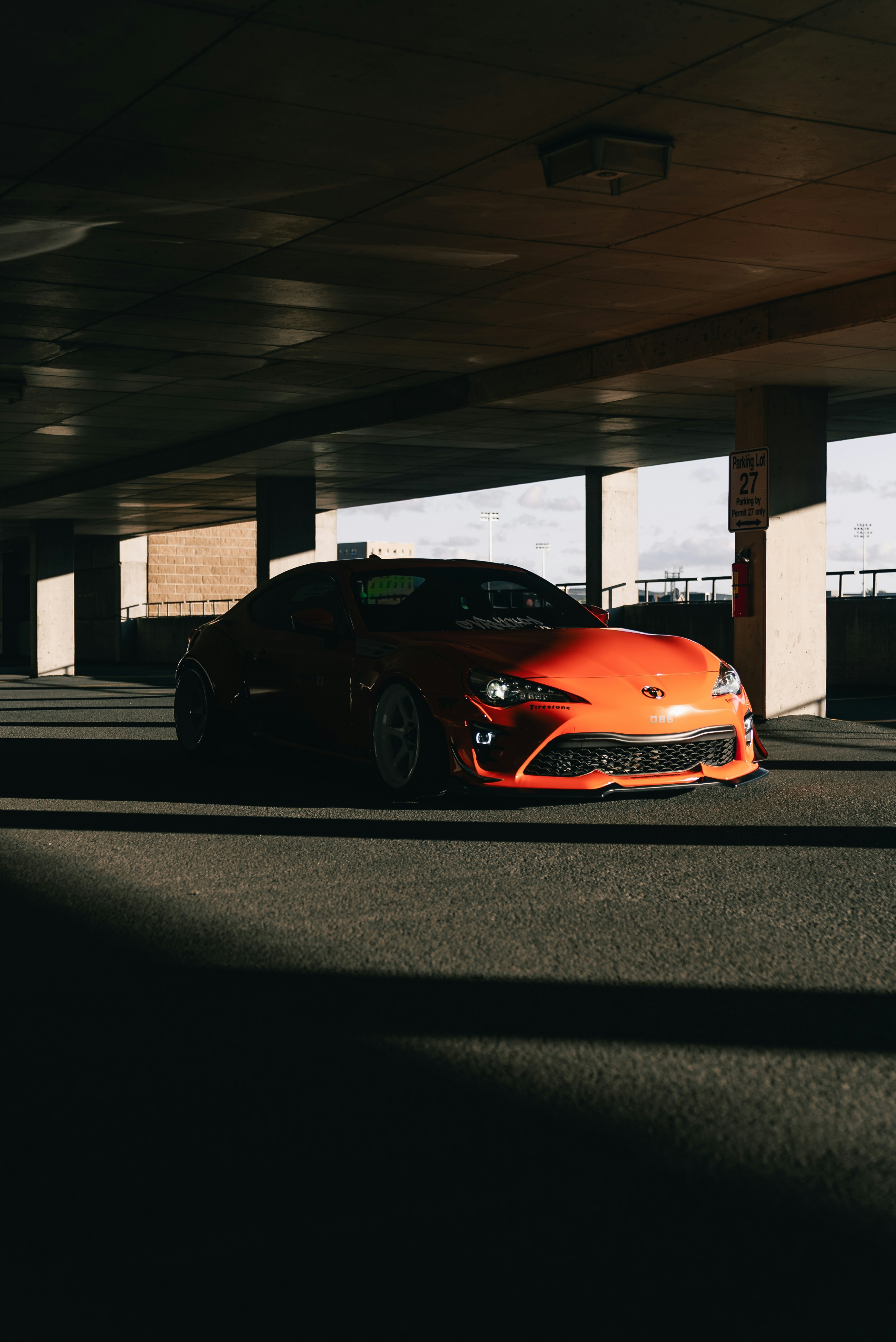 Sunlit Inferno: An Orange Destroyer under the Parking Loft