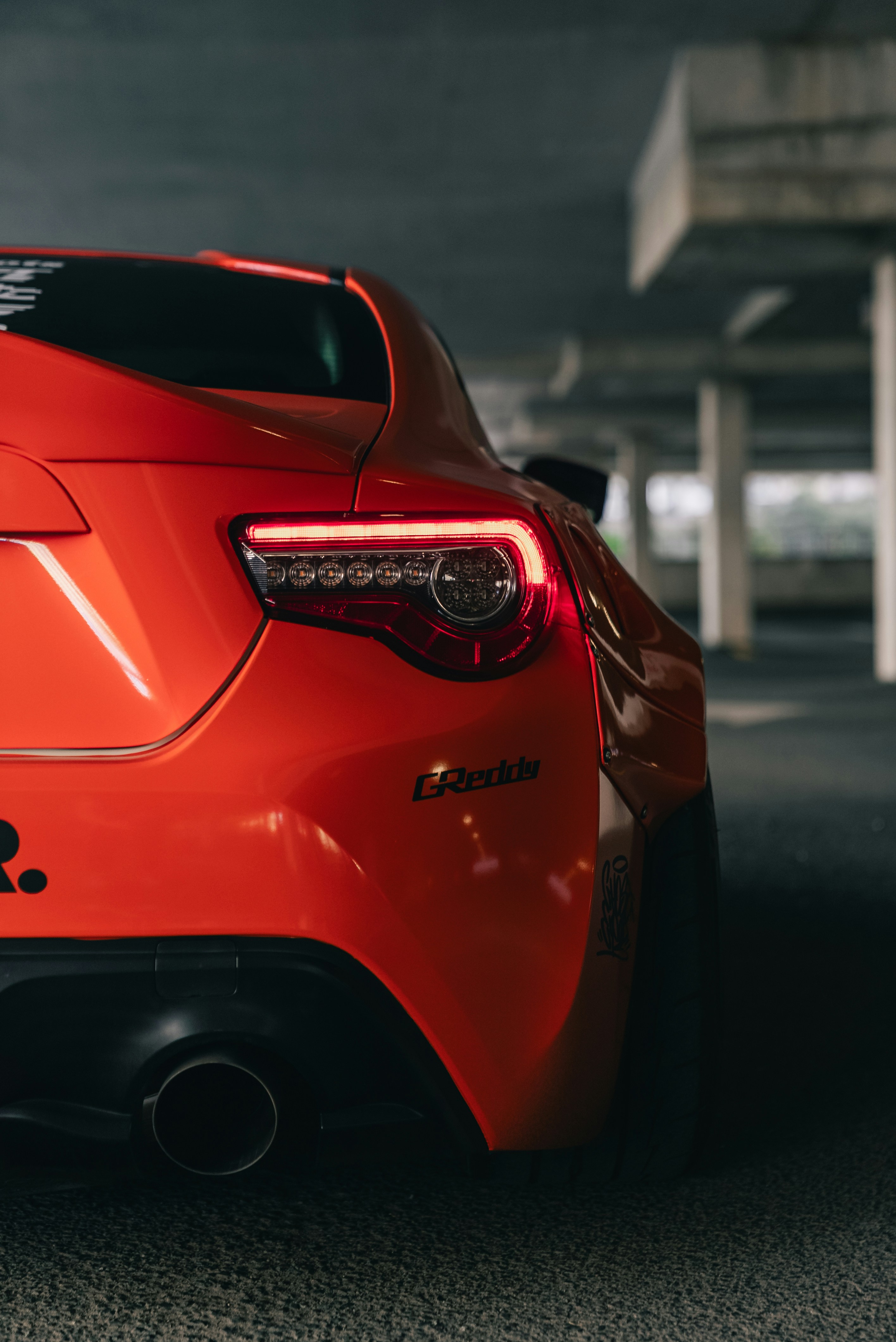 Orange Rear Quarter Glance: Precision and Power in the Parking Lot