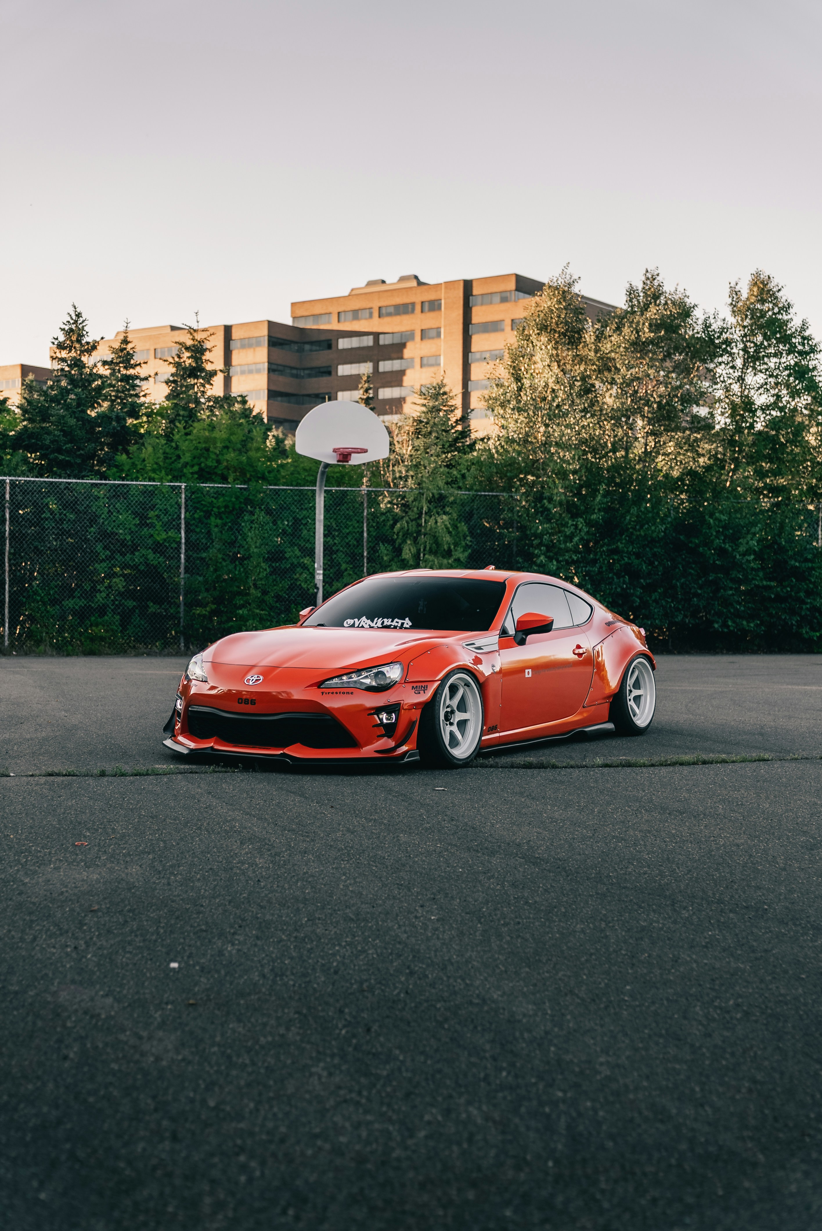 Low-ride Red: A Stance-Ready Sports Coupe on an Empty Court