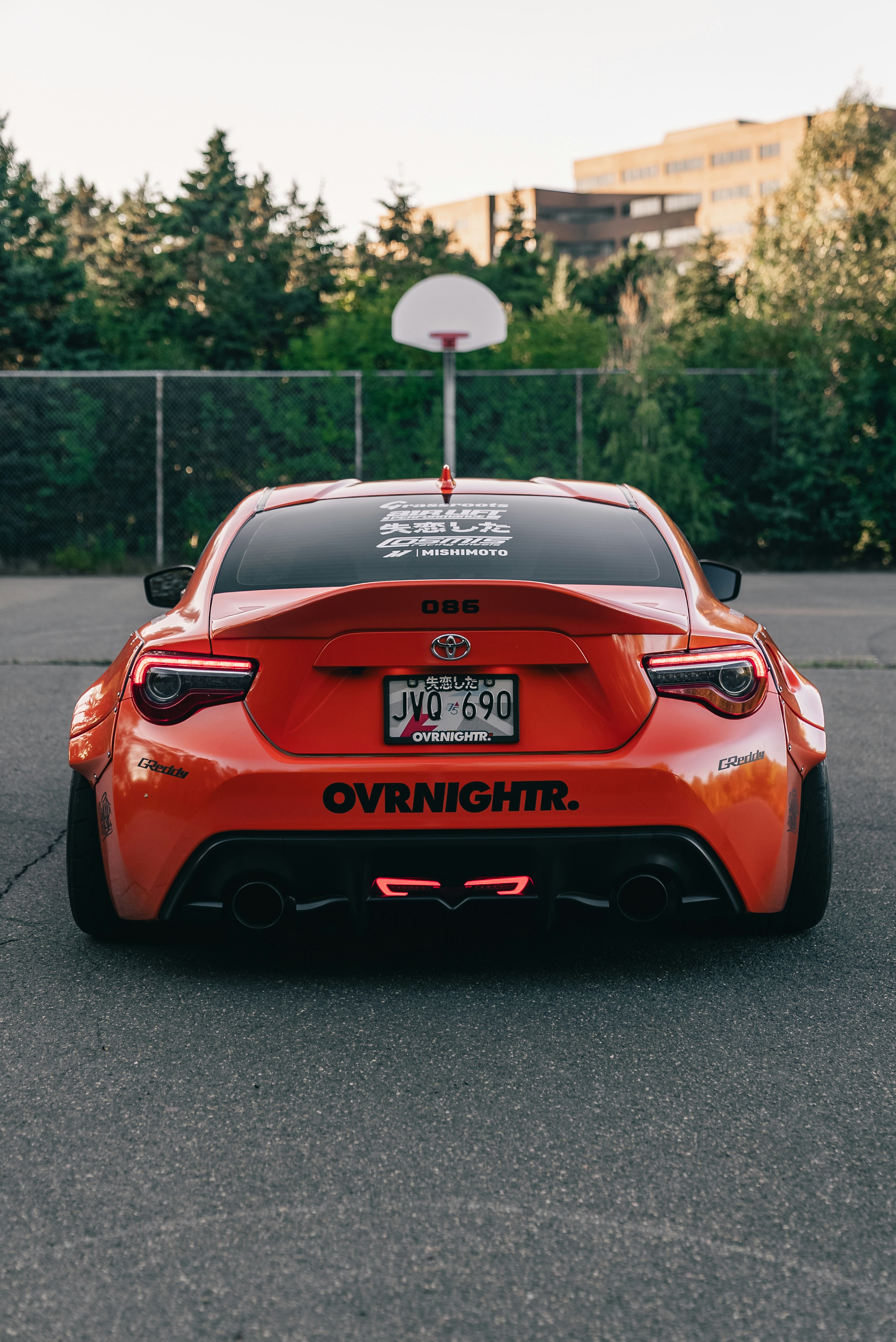 Rear View of a Fiery Orange Toyota with Night-Ready Graphics