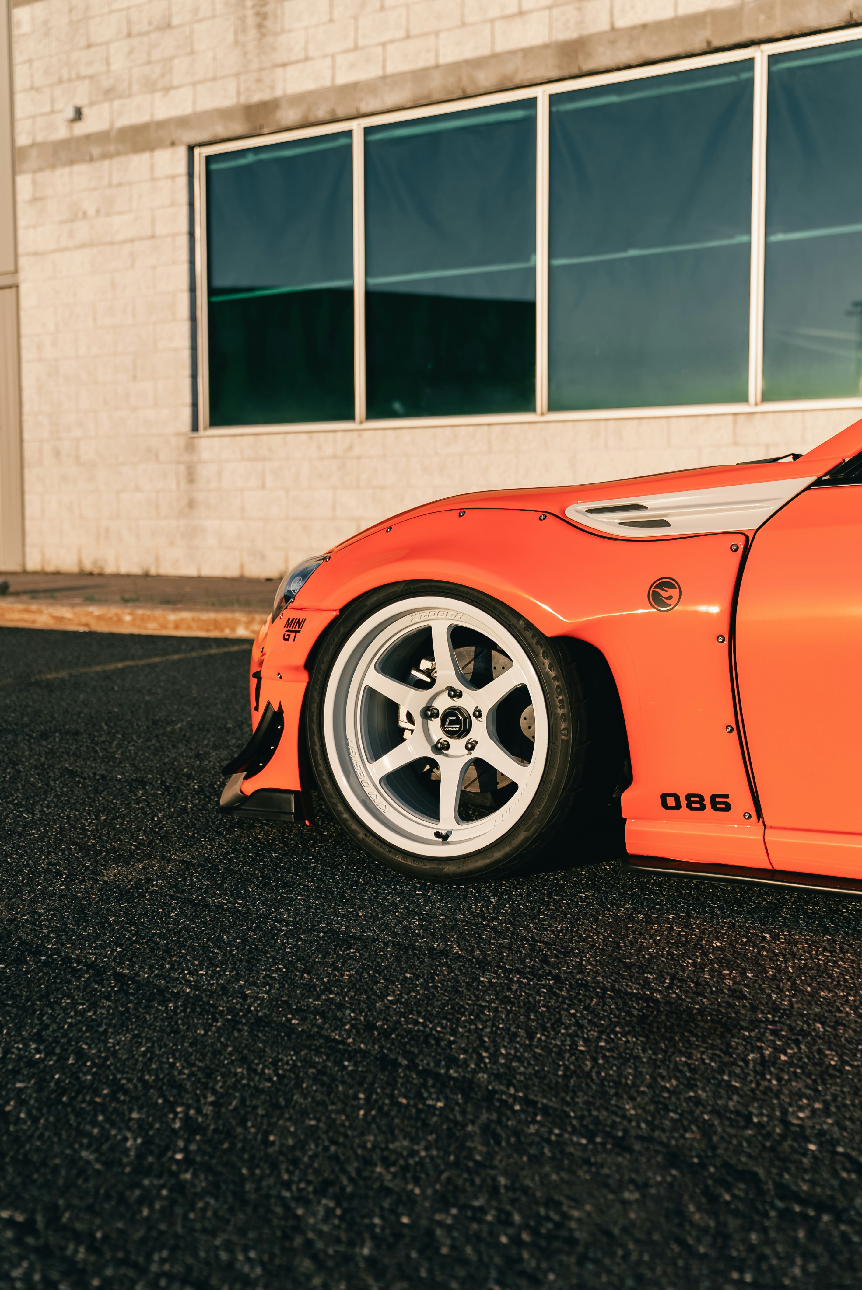 Orange Drift: Low-Aride Focus on the Front Wheel and Fenders