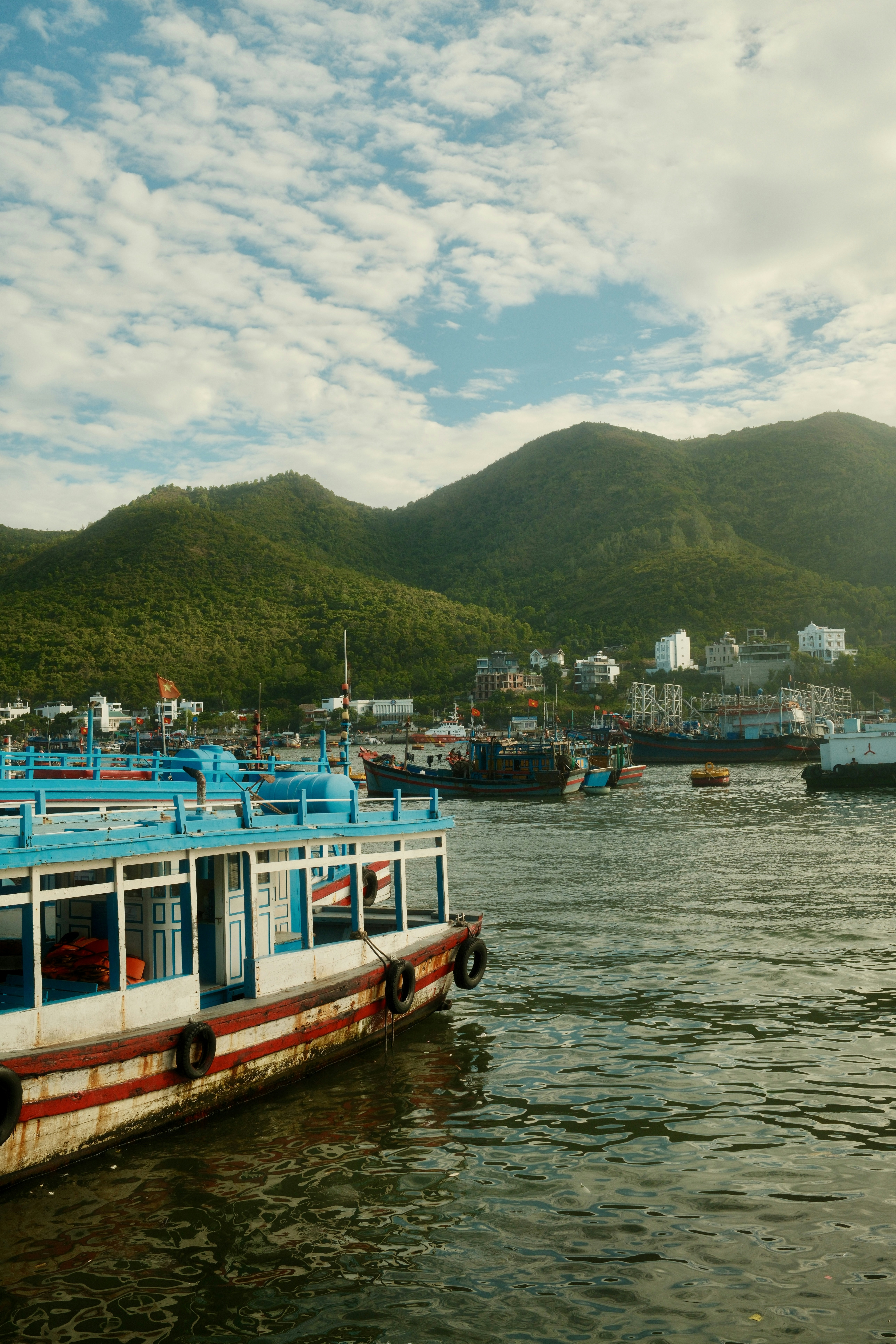 Blue-boats at the Riverside Docks Under a Shield of Hills