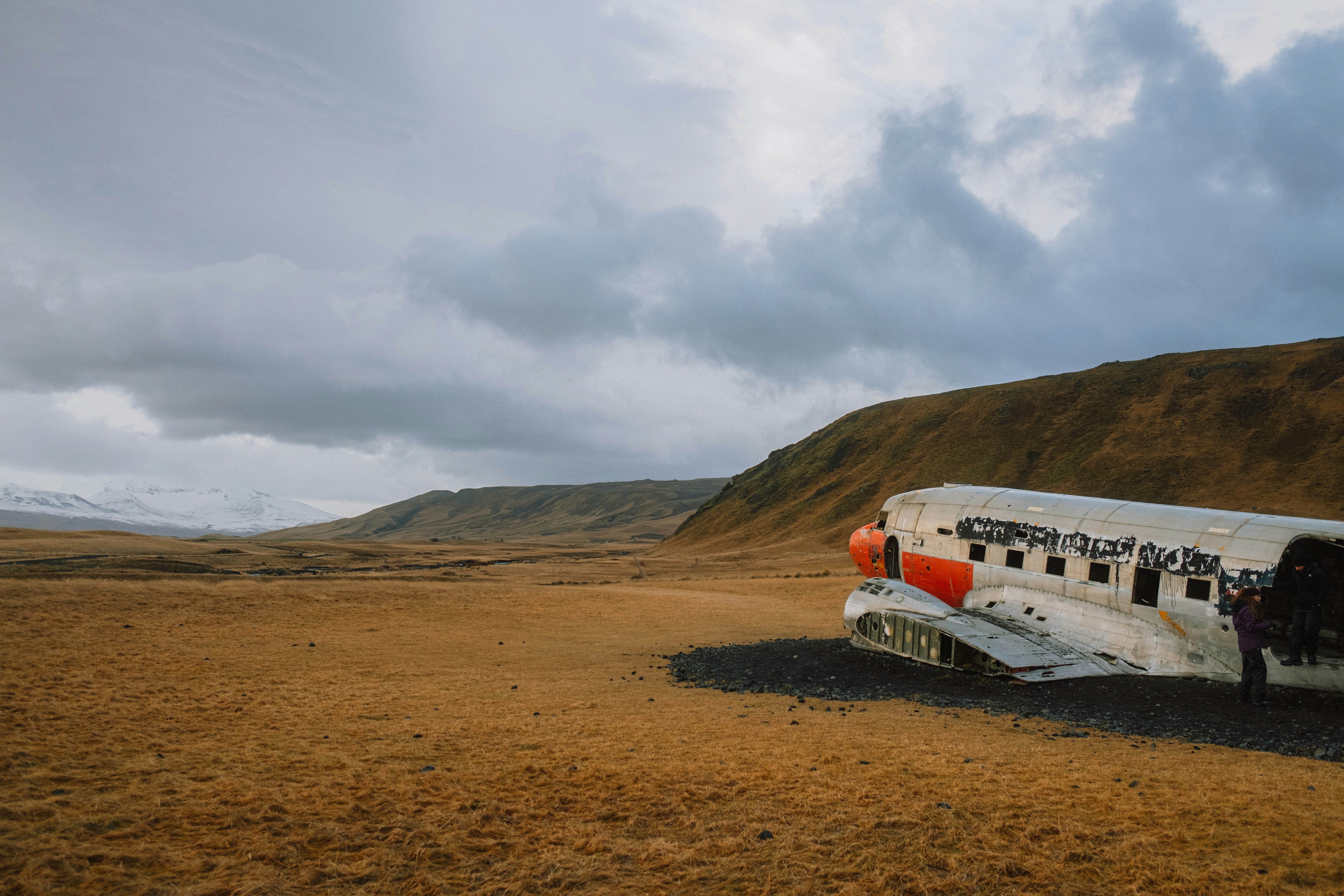 Deserted shoreline of burnt ochre plains with a sun-bleached hull