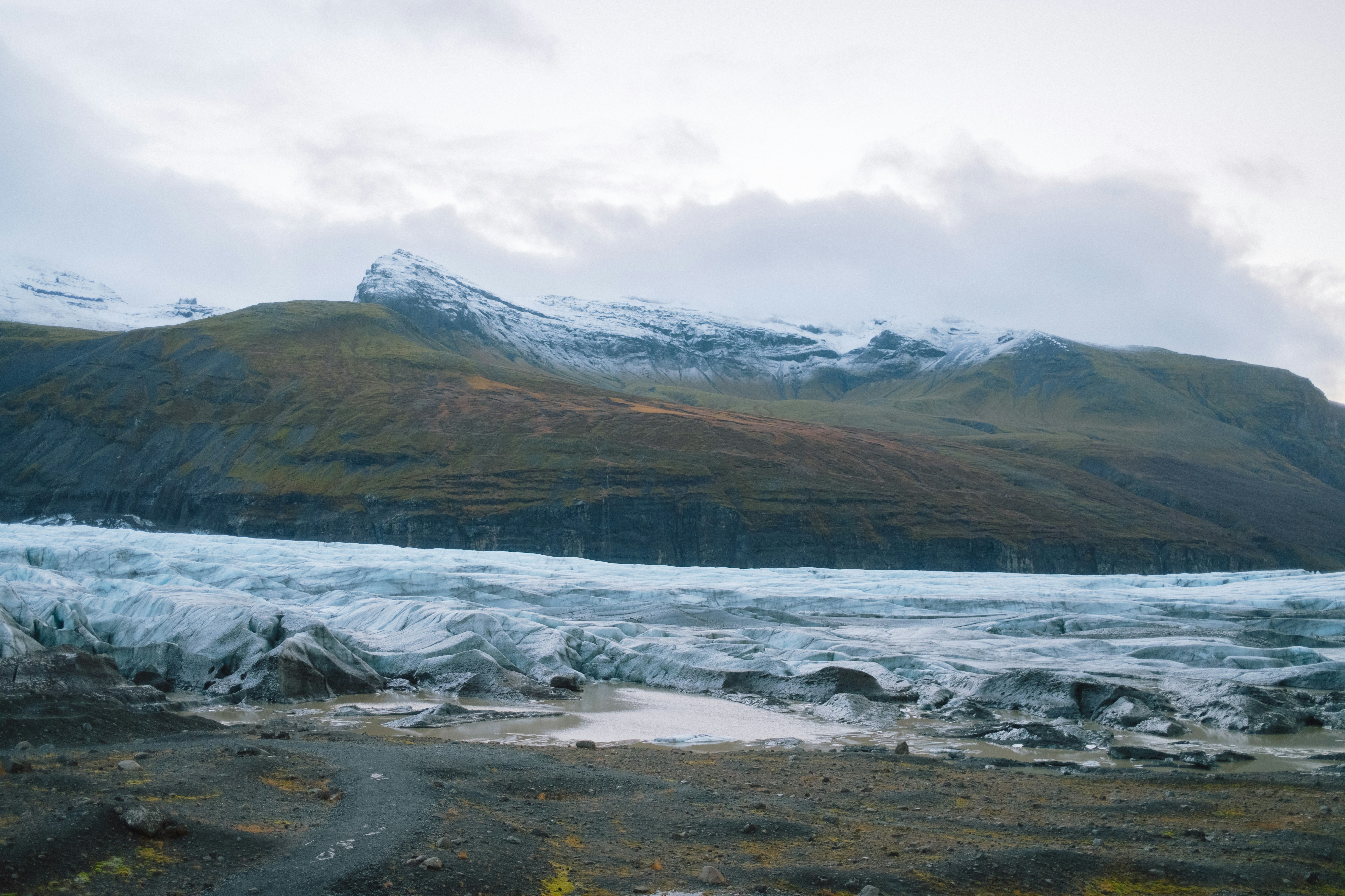 Glacier Edge Beneath Snow-dusted Peaks at Dusk
