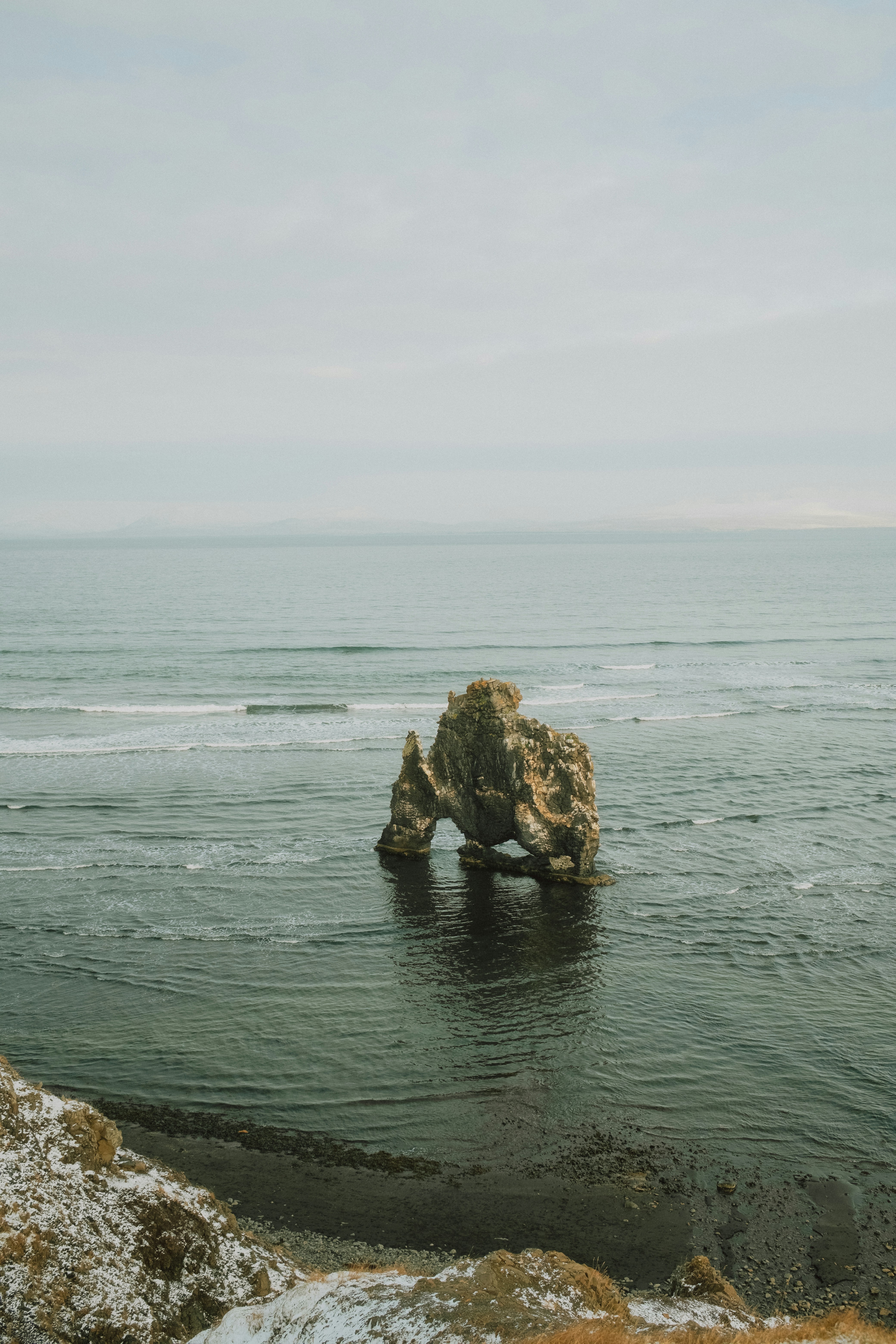 Sea Arch Reverie: The Lone Rock in Quiet Waters