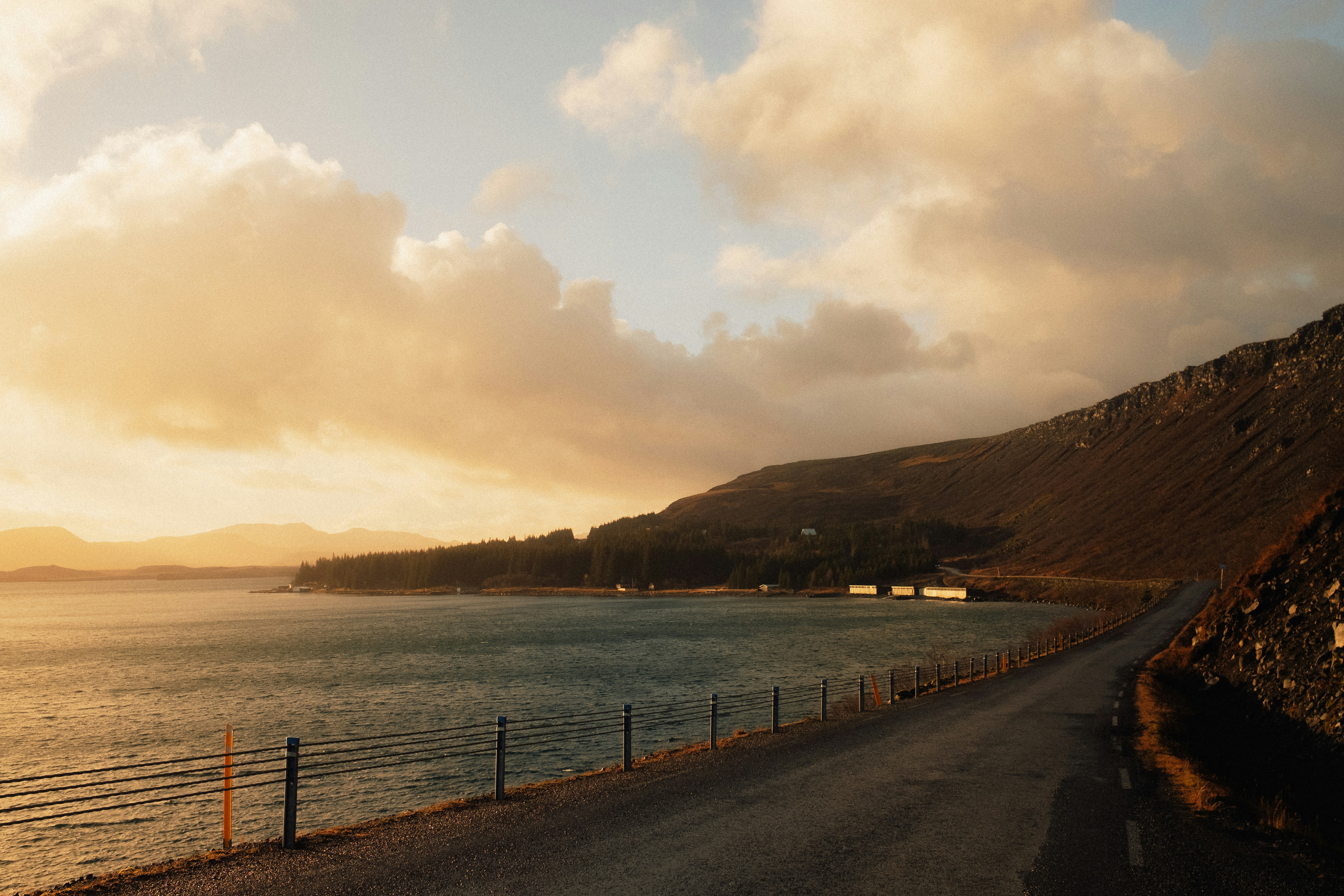 Golden Coastal Road: Sunlit Sea Cliff Path at Dusk