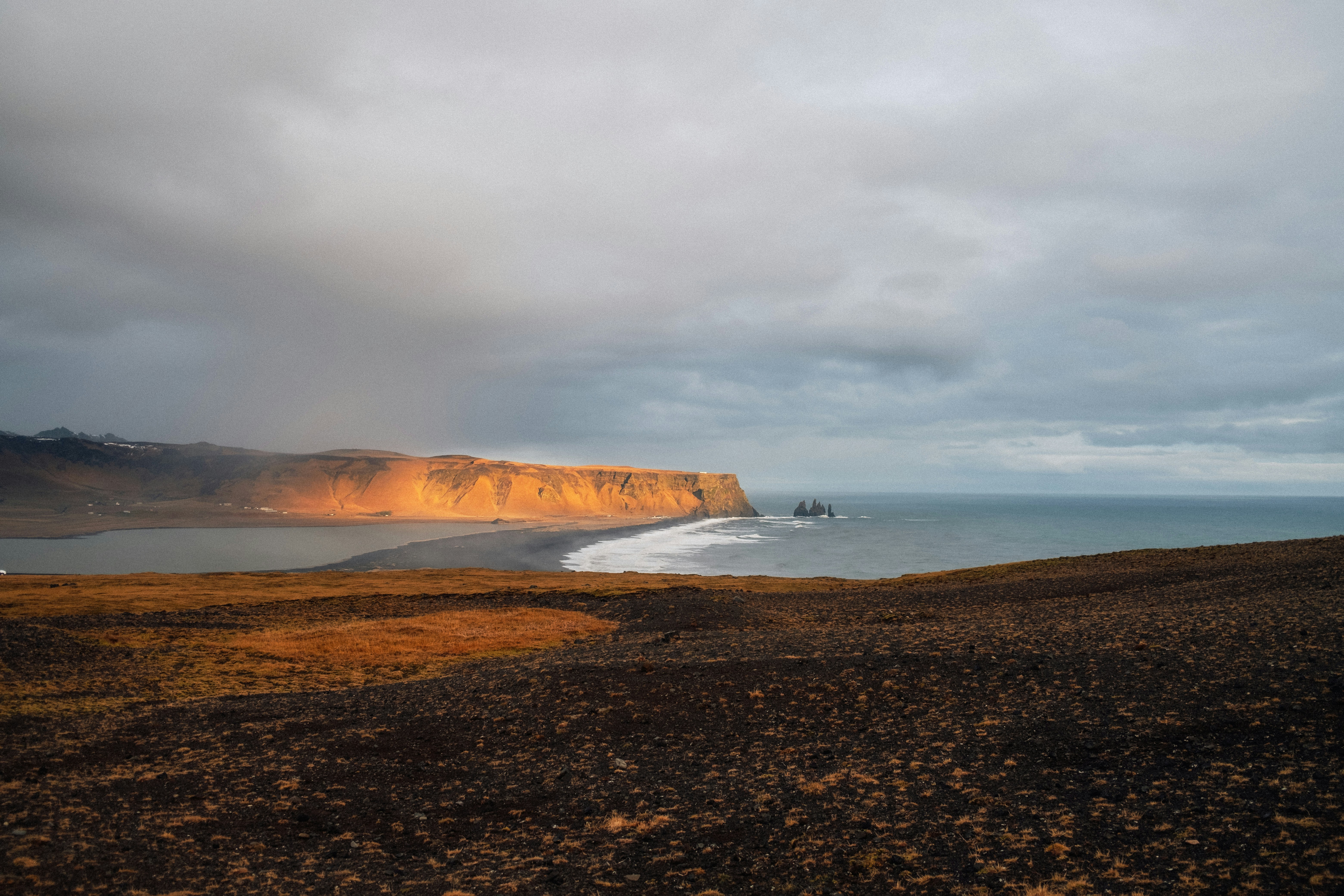Edge of Light: Golden Cliff Over a Quiet Shore