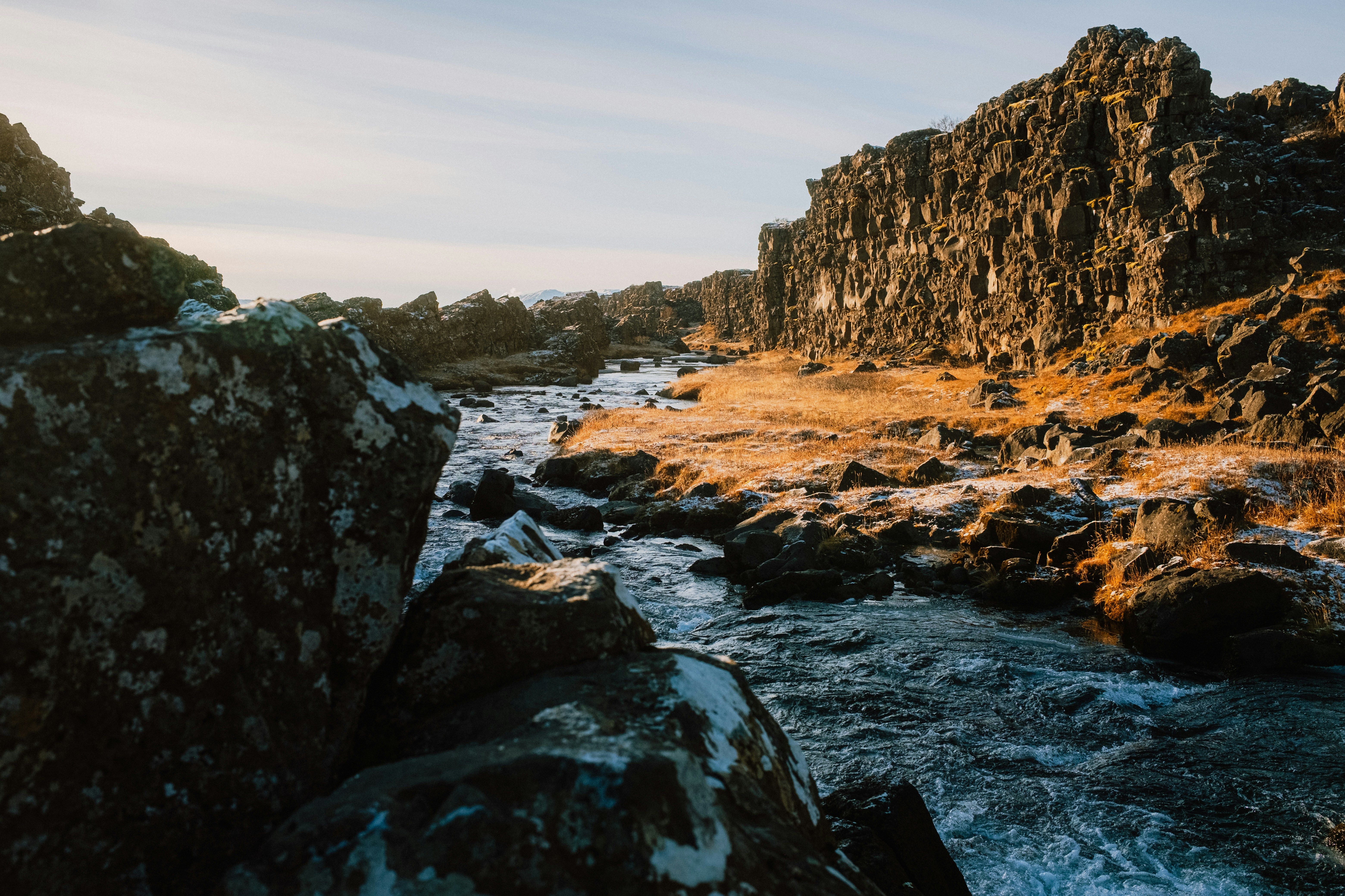 Sunlit Tidal Rift: Rugged Rocks and Lapping Water