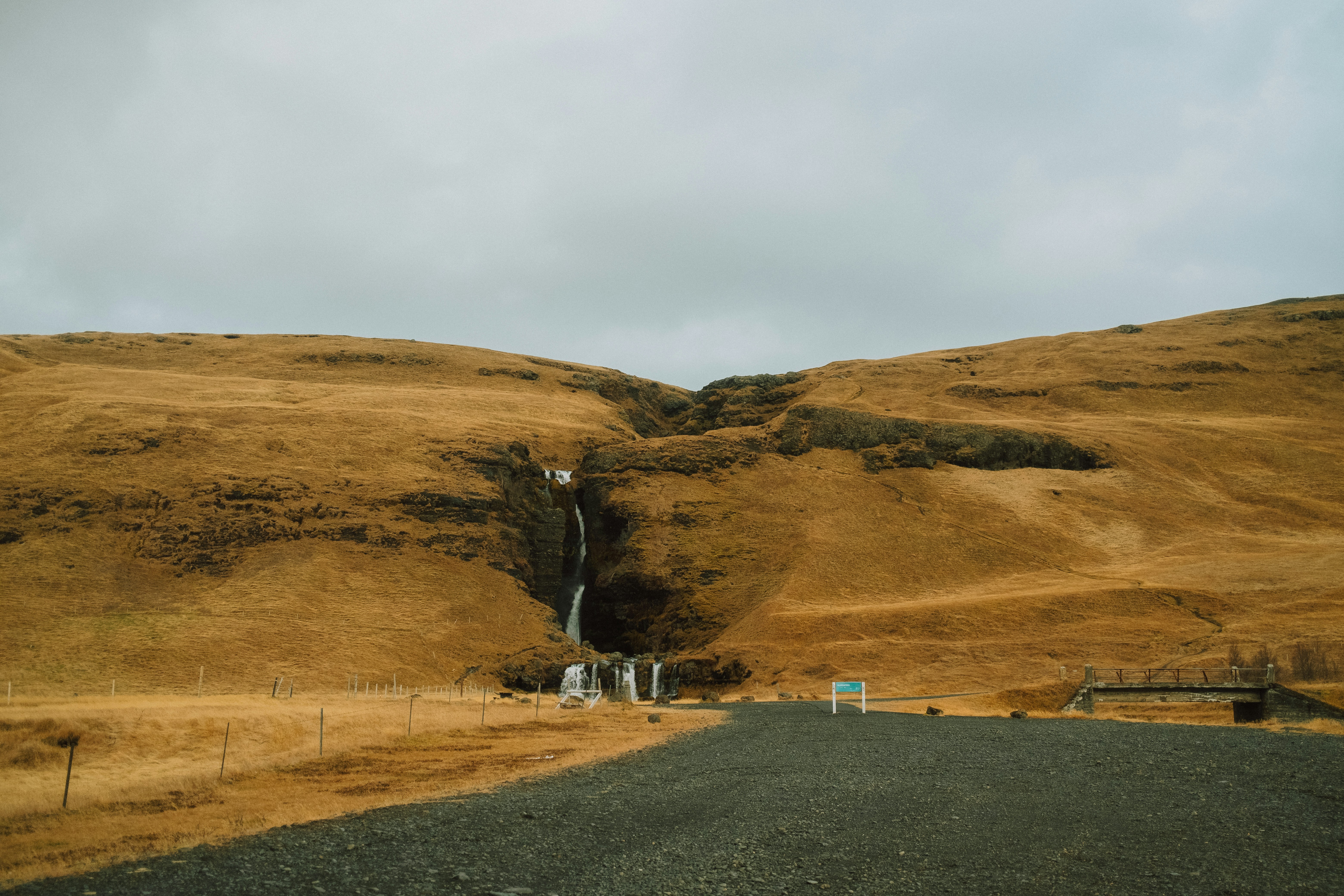 Golden Highlands Sunset: A Quiet Plume of Water Among Rugged Slopes