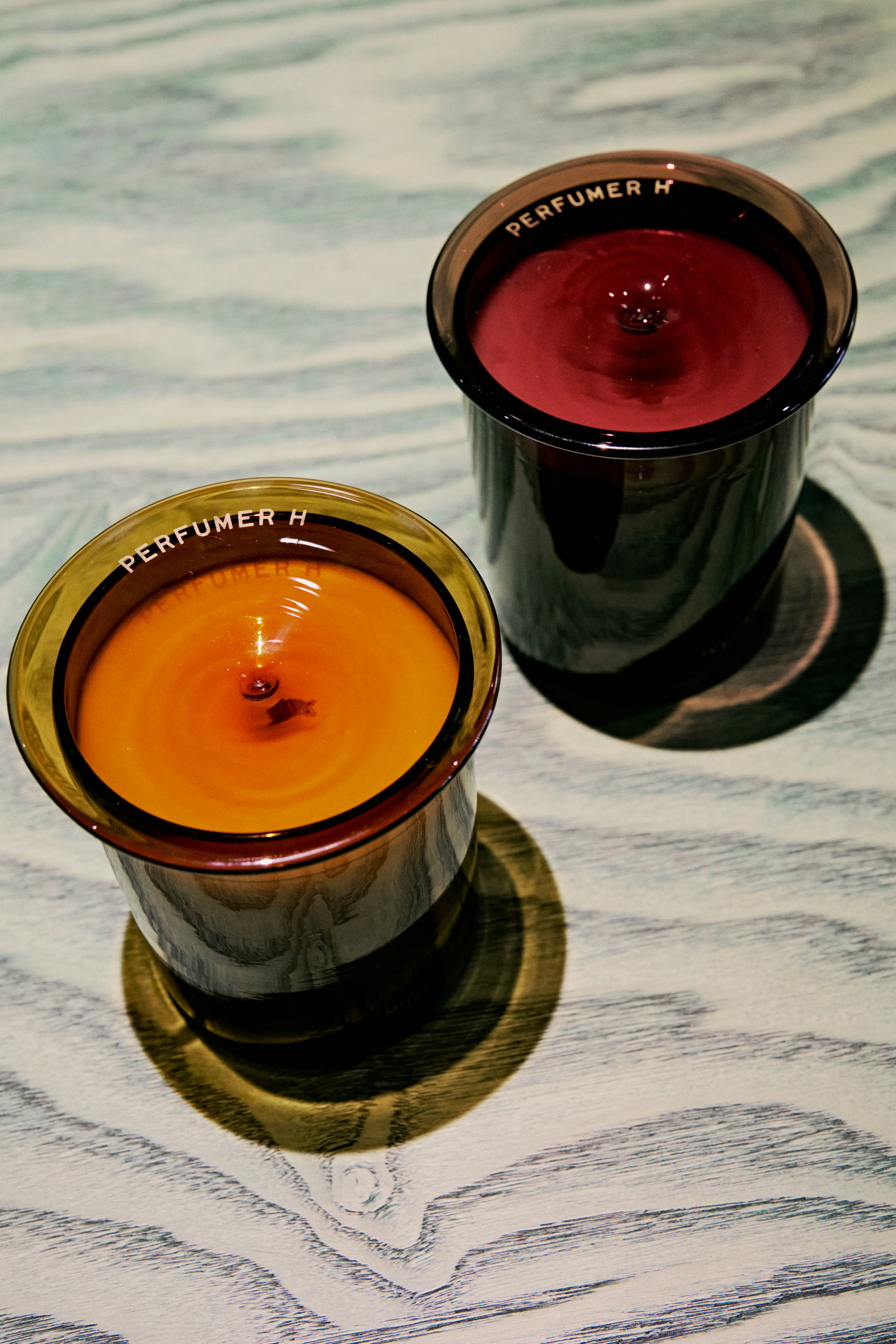 Twin Glass Vials of Vivid Ink Resting on Grainy Table
