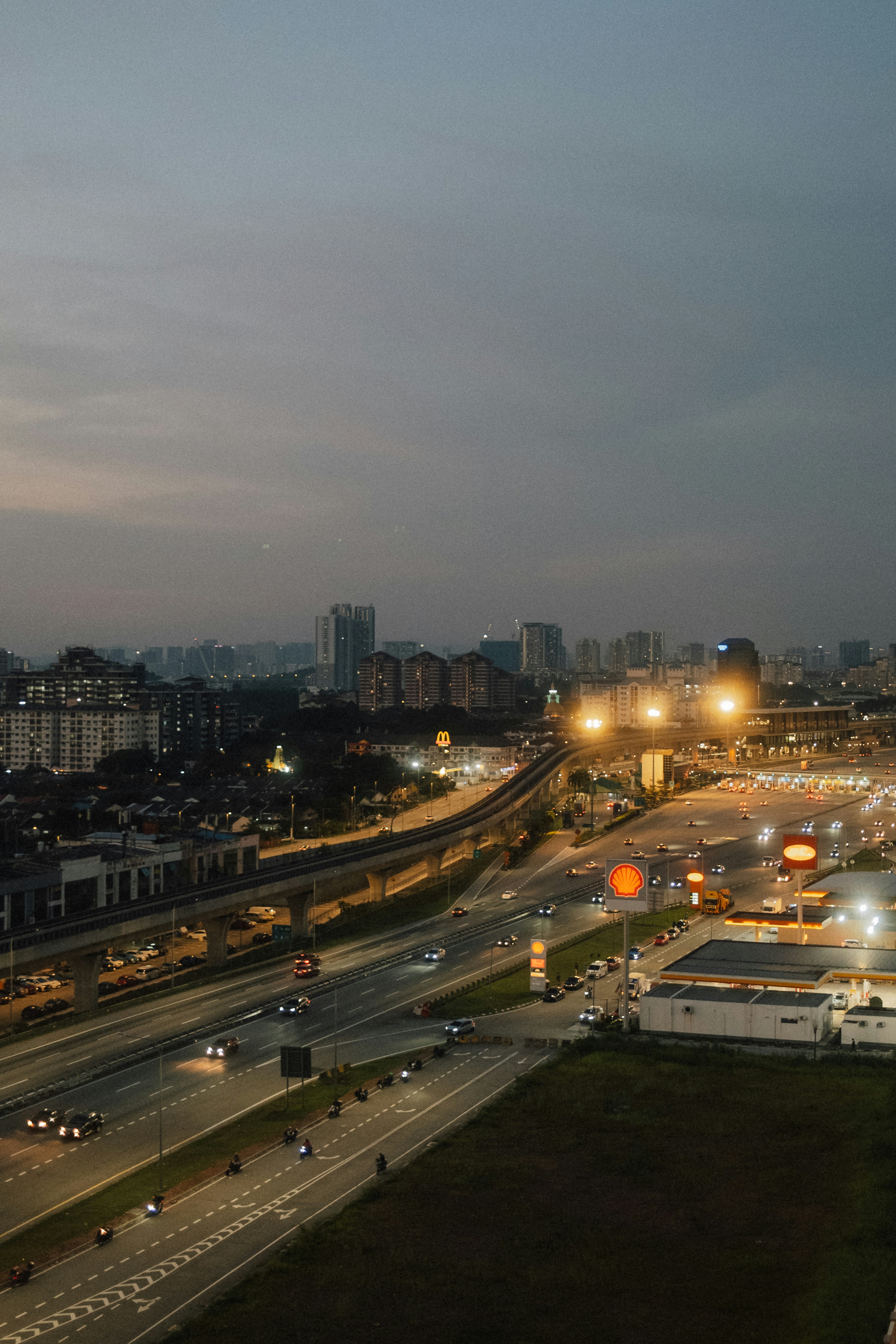 Evening Metro Artery: Neon Ribbons Over a City Boulevard