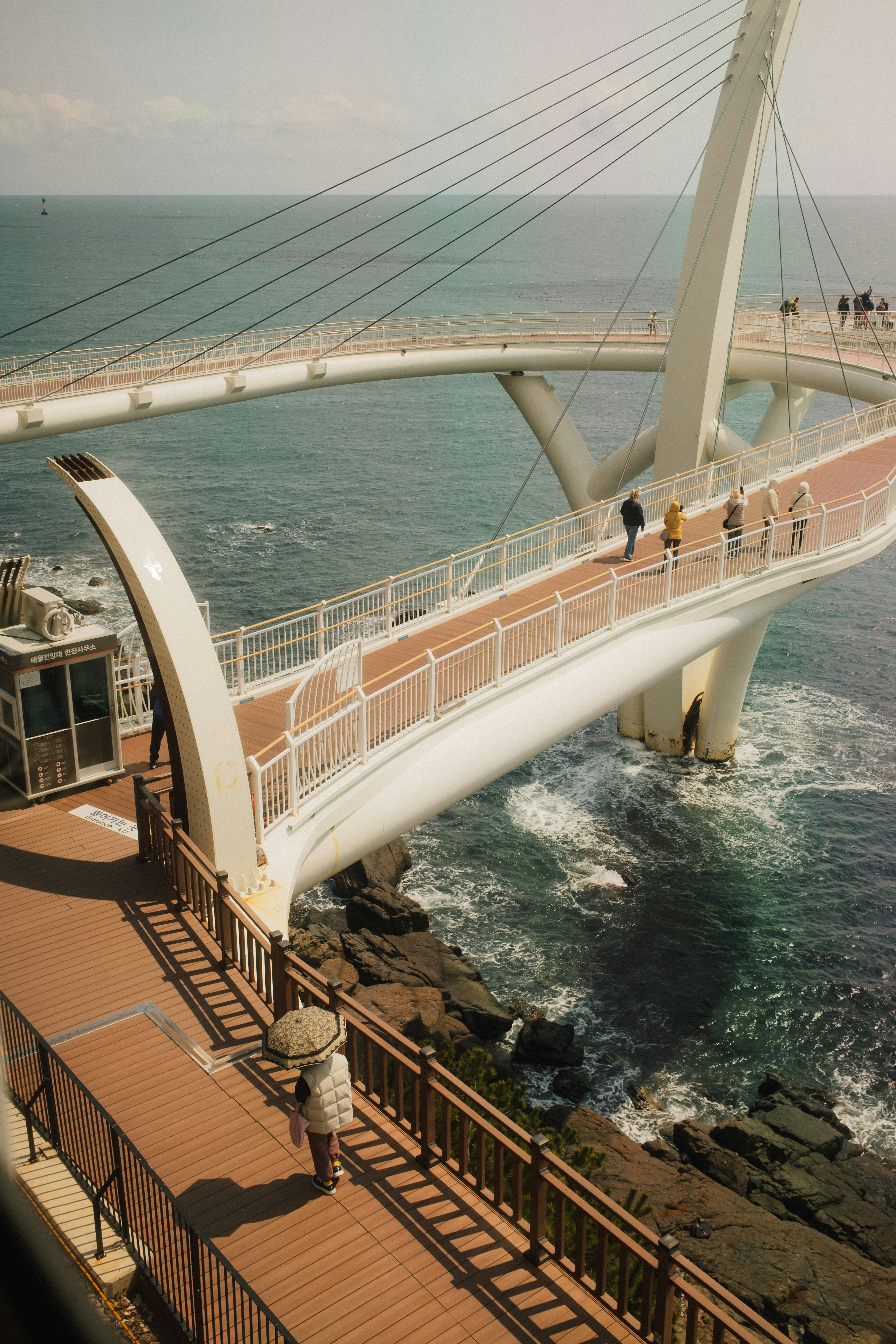 Curved Bridge Over Turquoise Seas: A Walk Along the Waterfront