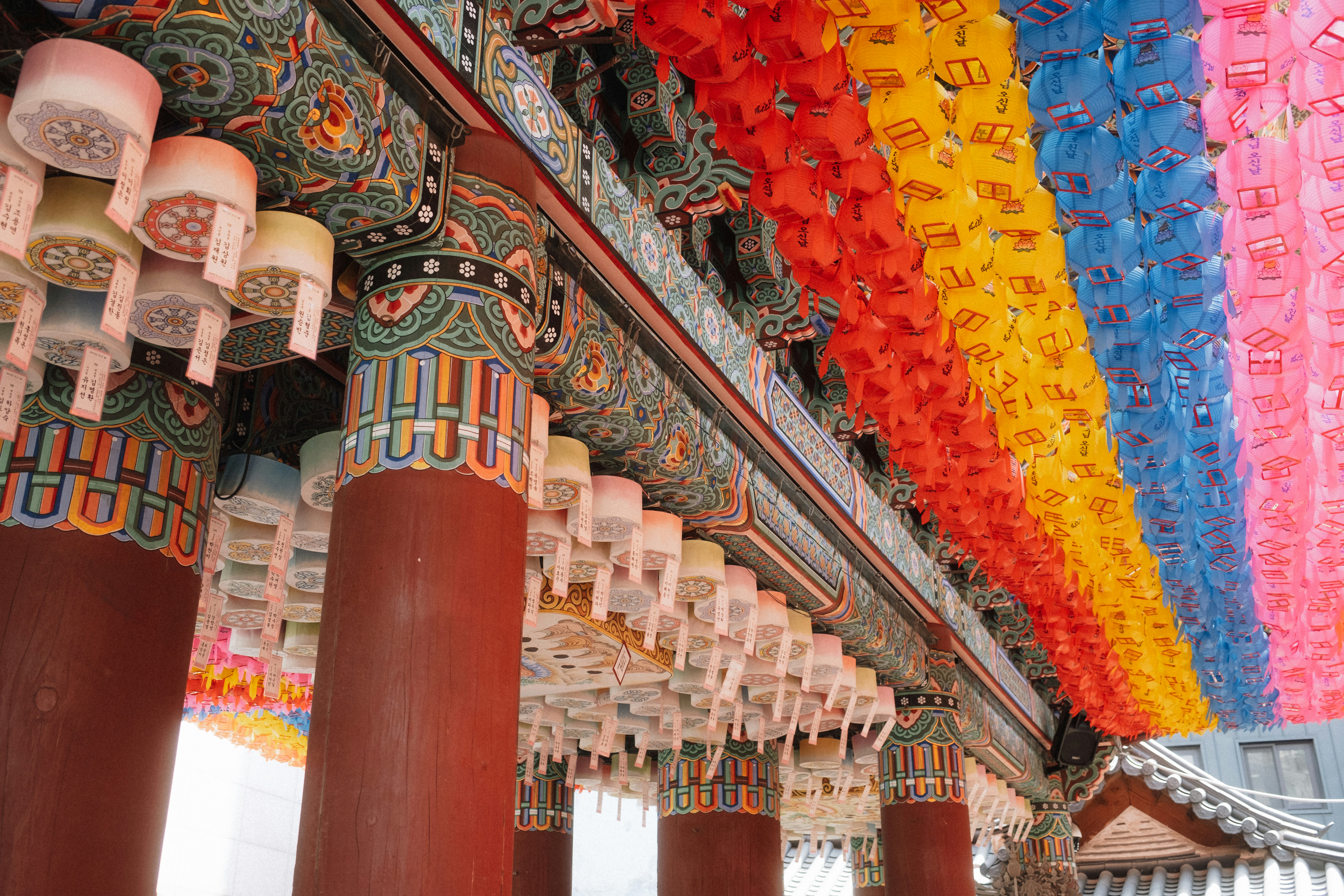 Colorful Roof Ceremony: Lanterns Draped Over Ancient Columns