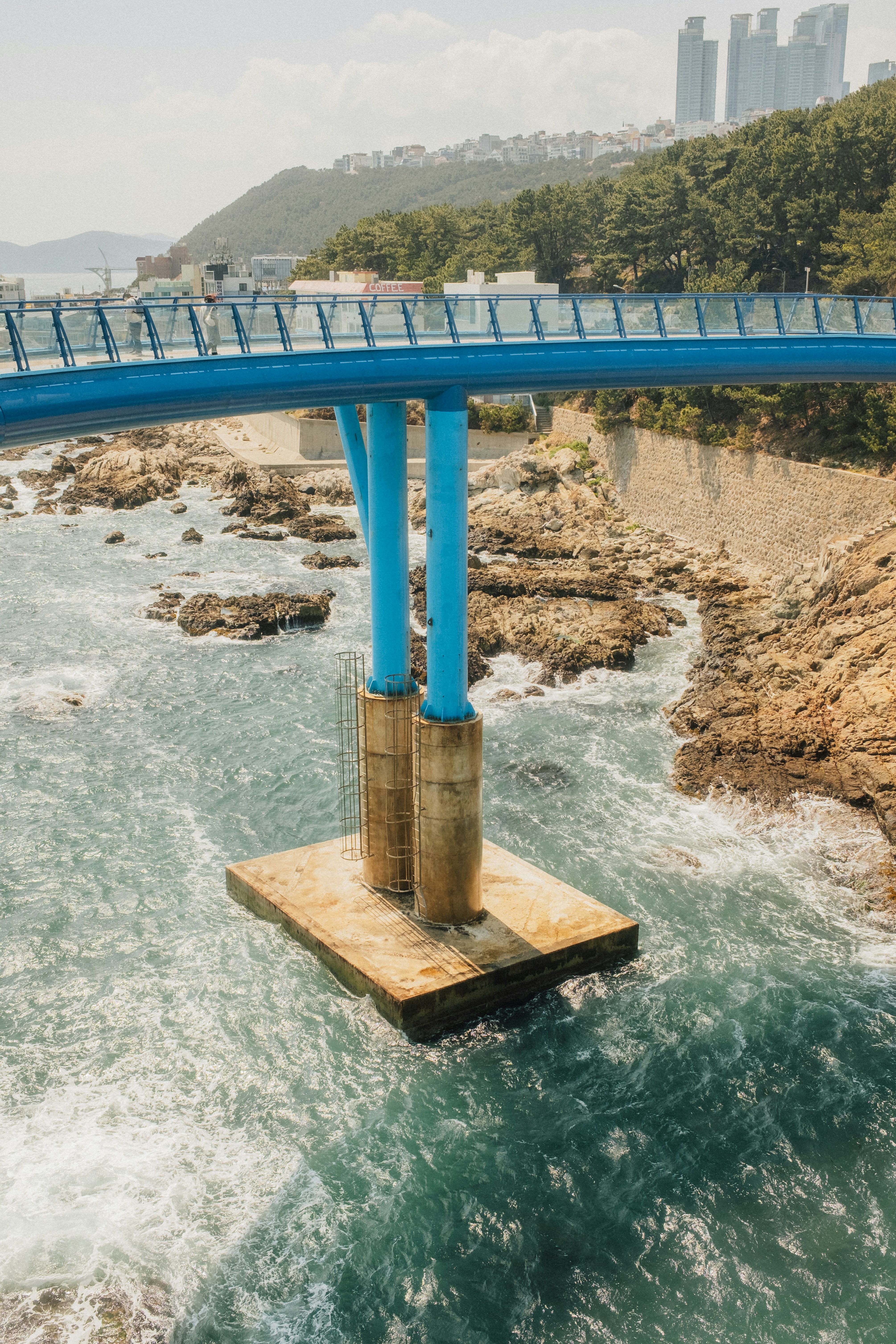 Blue Girder Bridge Spanning Turbulent Coastal Waters