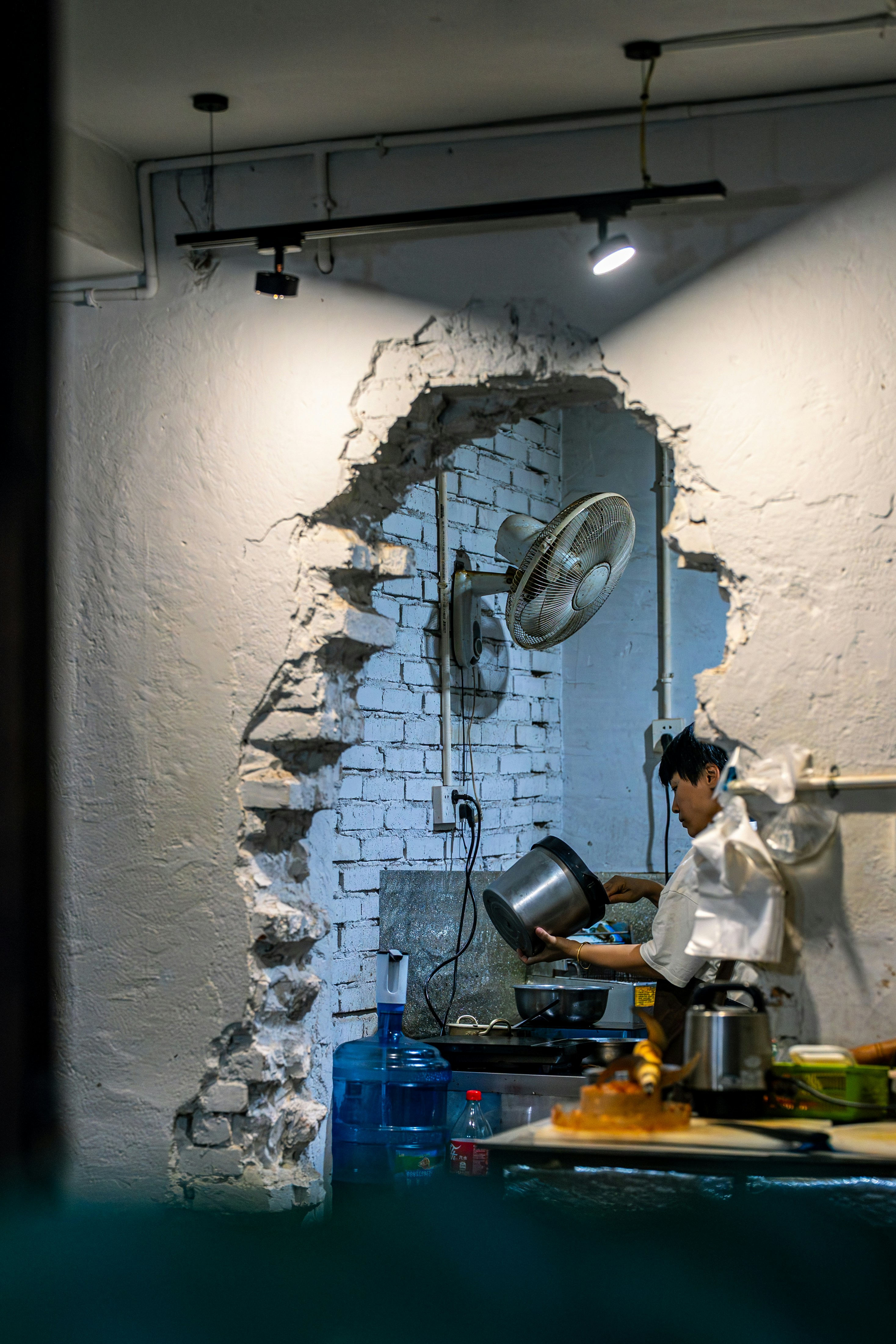 Chef in a Neon Kitchen: Framed by a Rough Brick Cutout