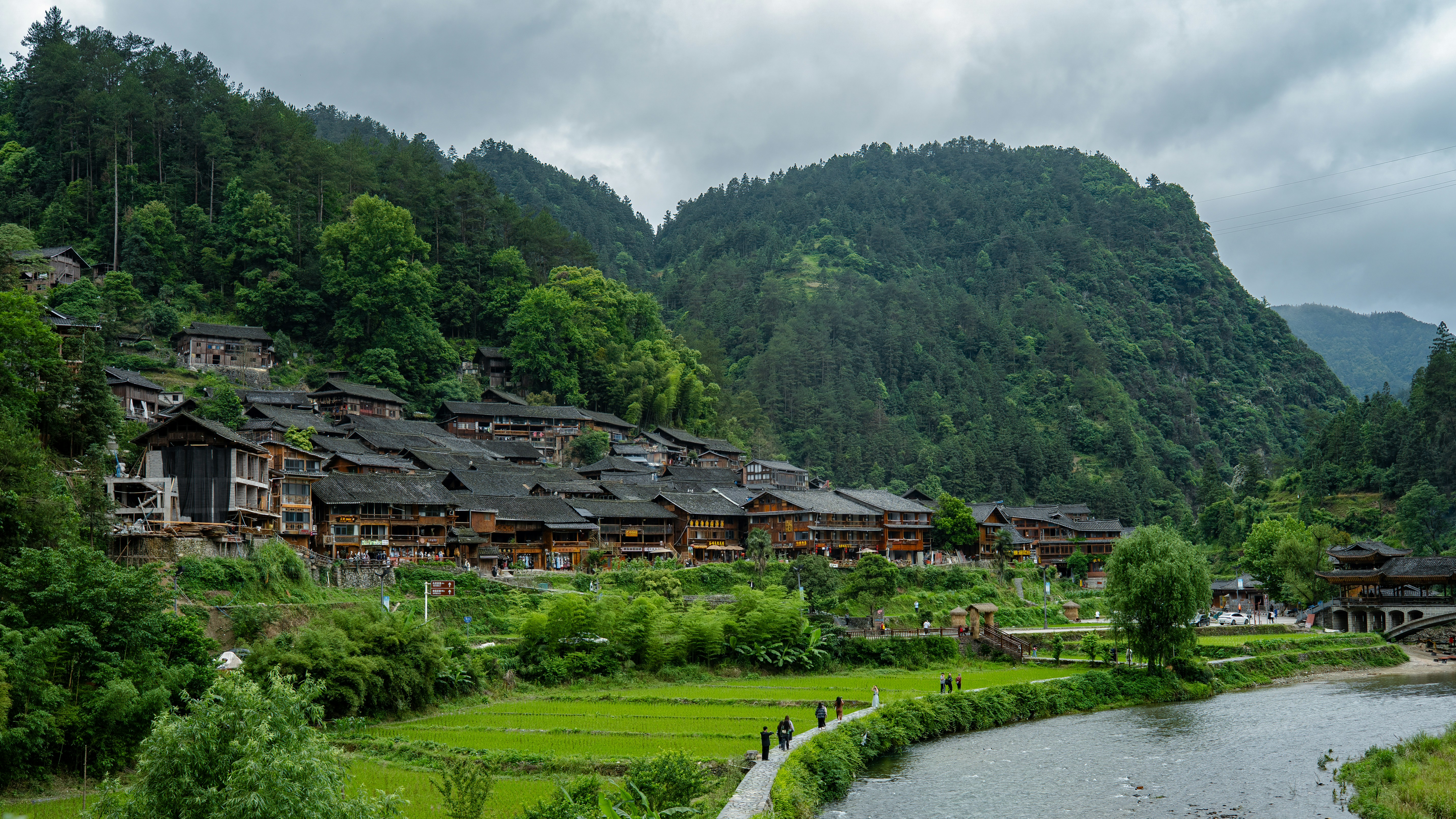 Silvan Village by the River: Timber Trenches and Green Slopes