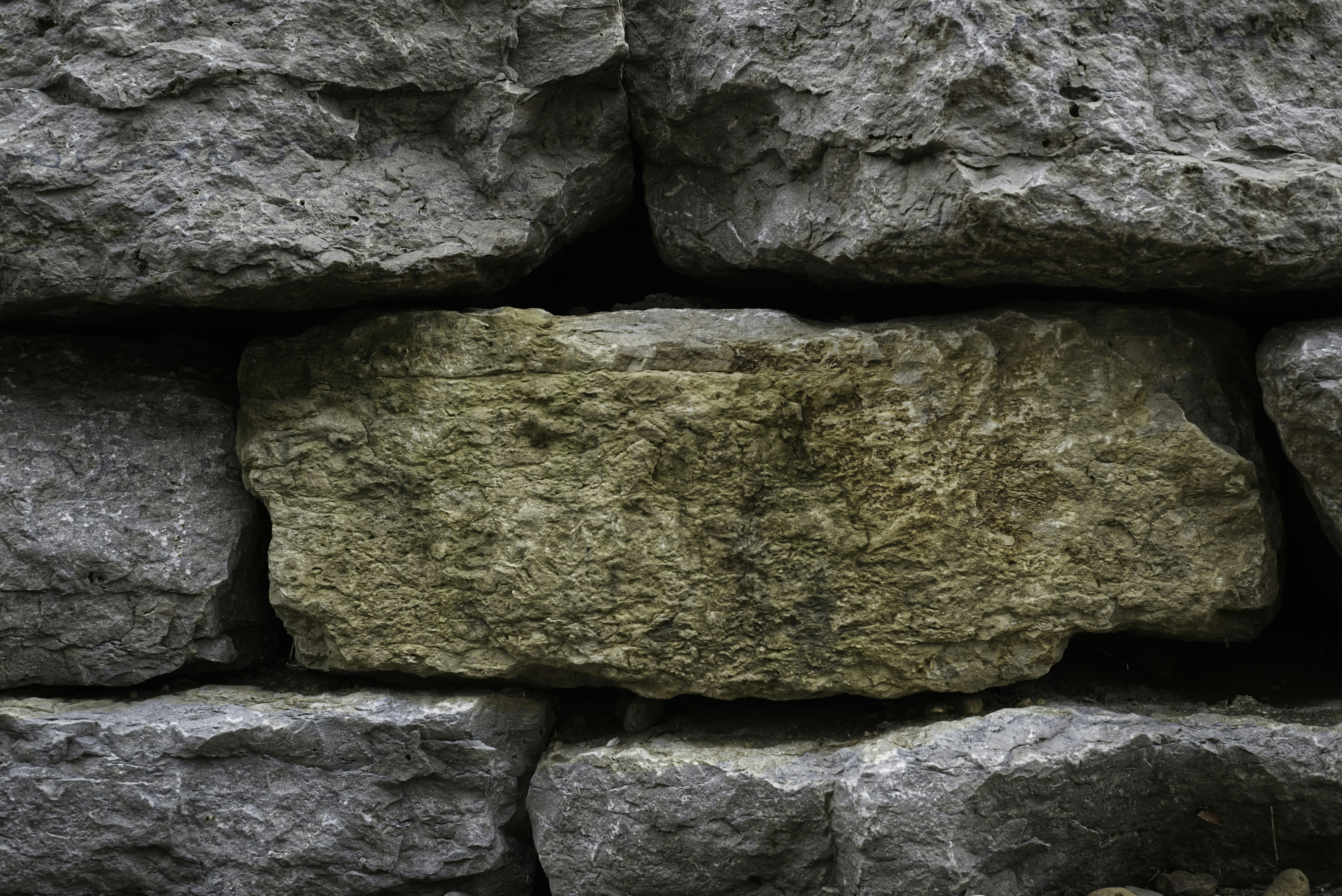 Weathered Block: A Close-Up of Rustic Stone Texture