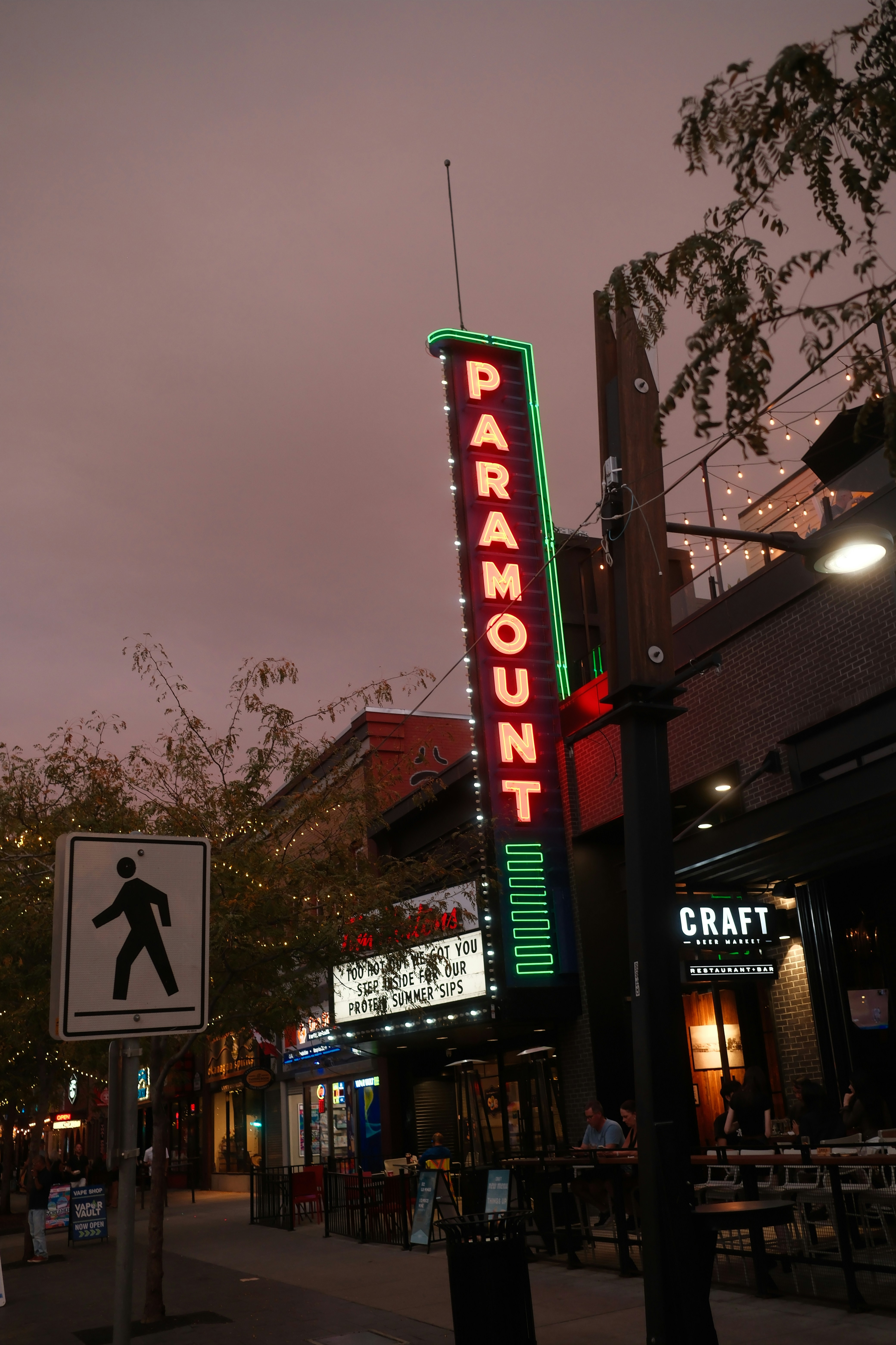 Neon Signage and Street Terrace Under dusk Glow