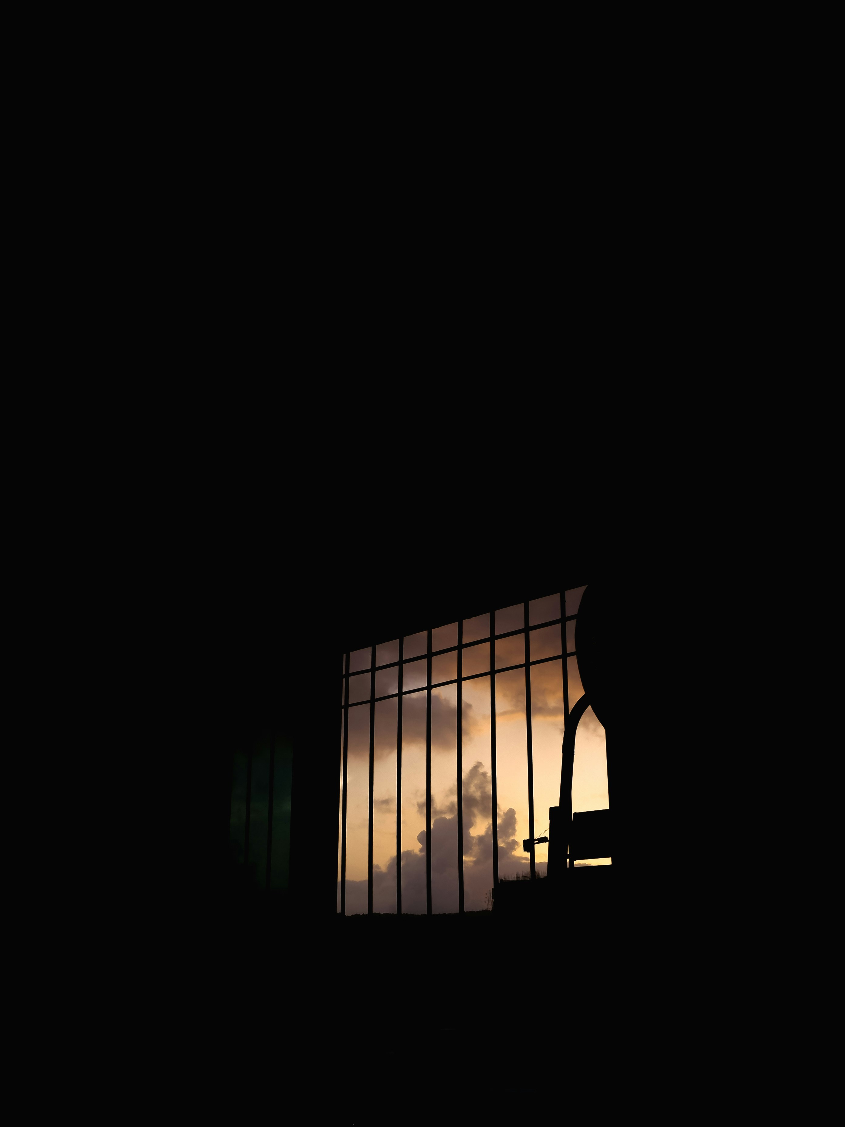 Silhouetted Window Framing a Sunset Vista