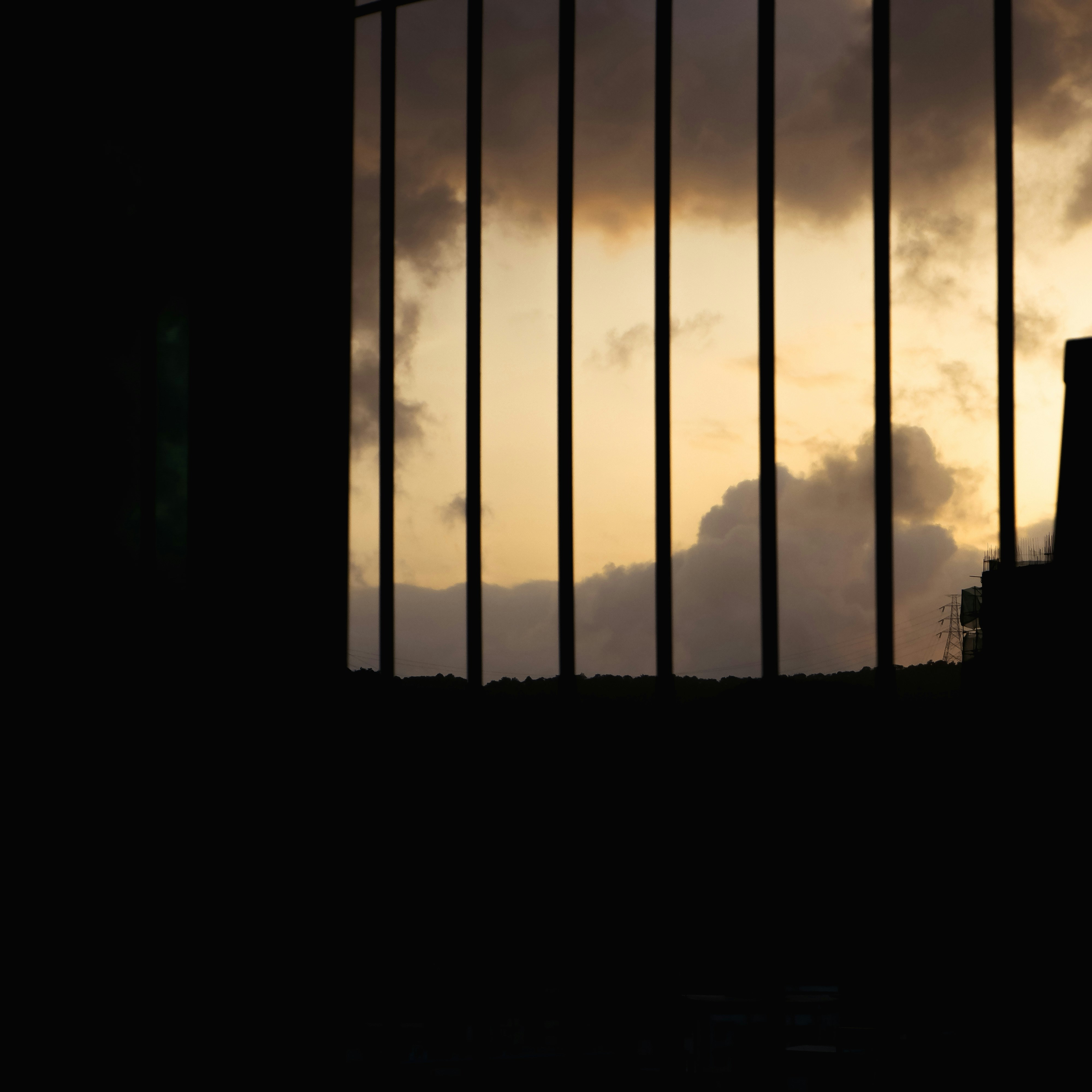 Silhouetted Bars at Sunset: A Horizon of Quiet Gloom
