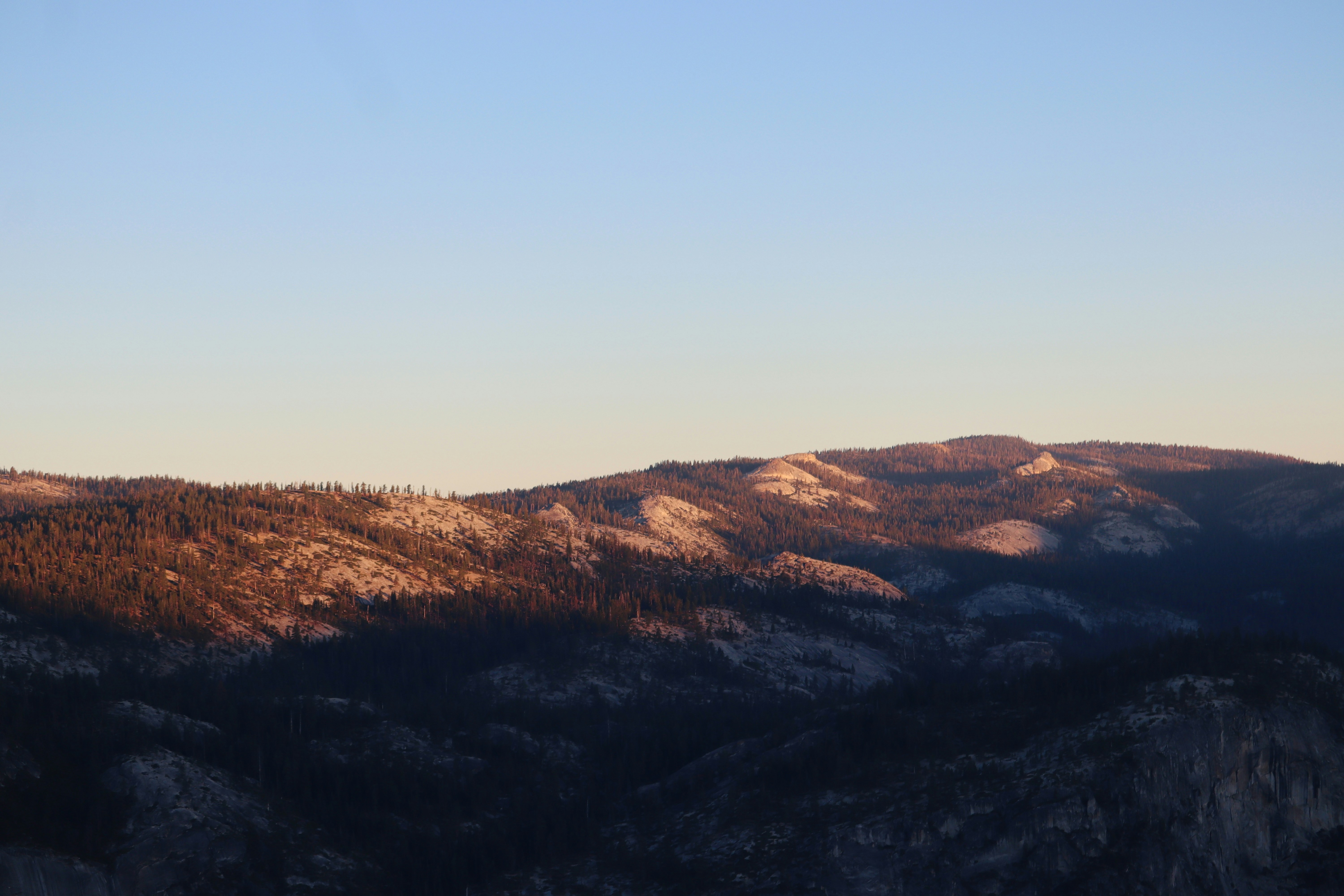 Dawn’s Gentle Ridge: Sunlit Crest Over Quiet Valleys