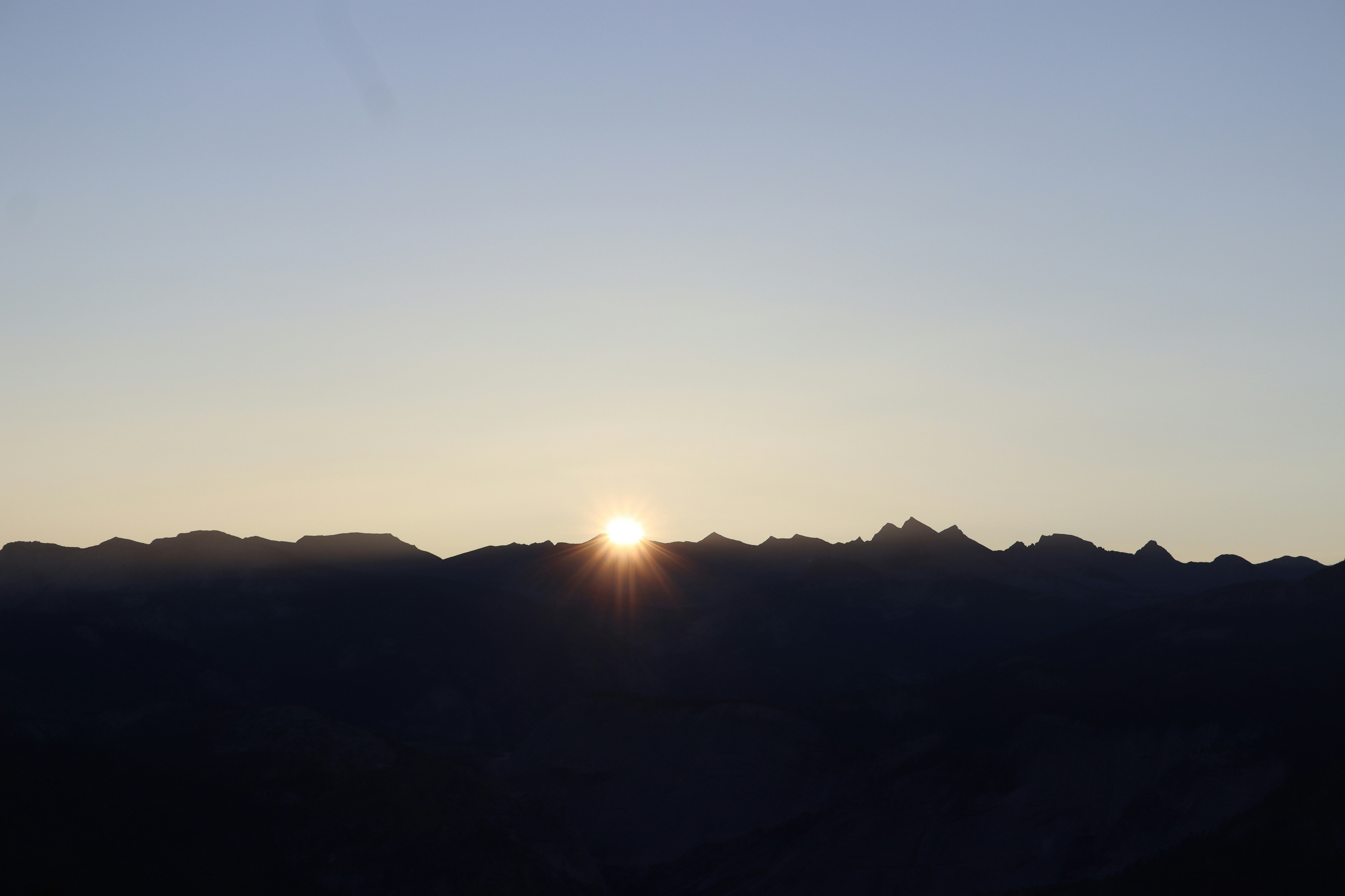Dawn Quiet on the Ridges: A Sun Puncturing the Ridge Line
