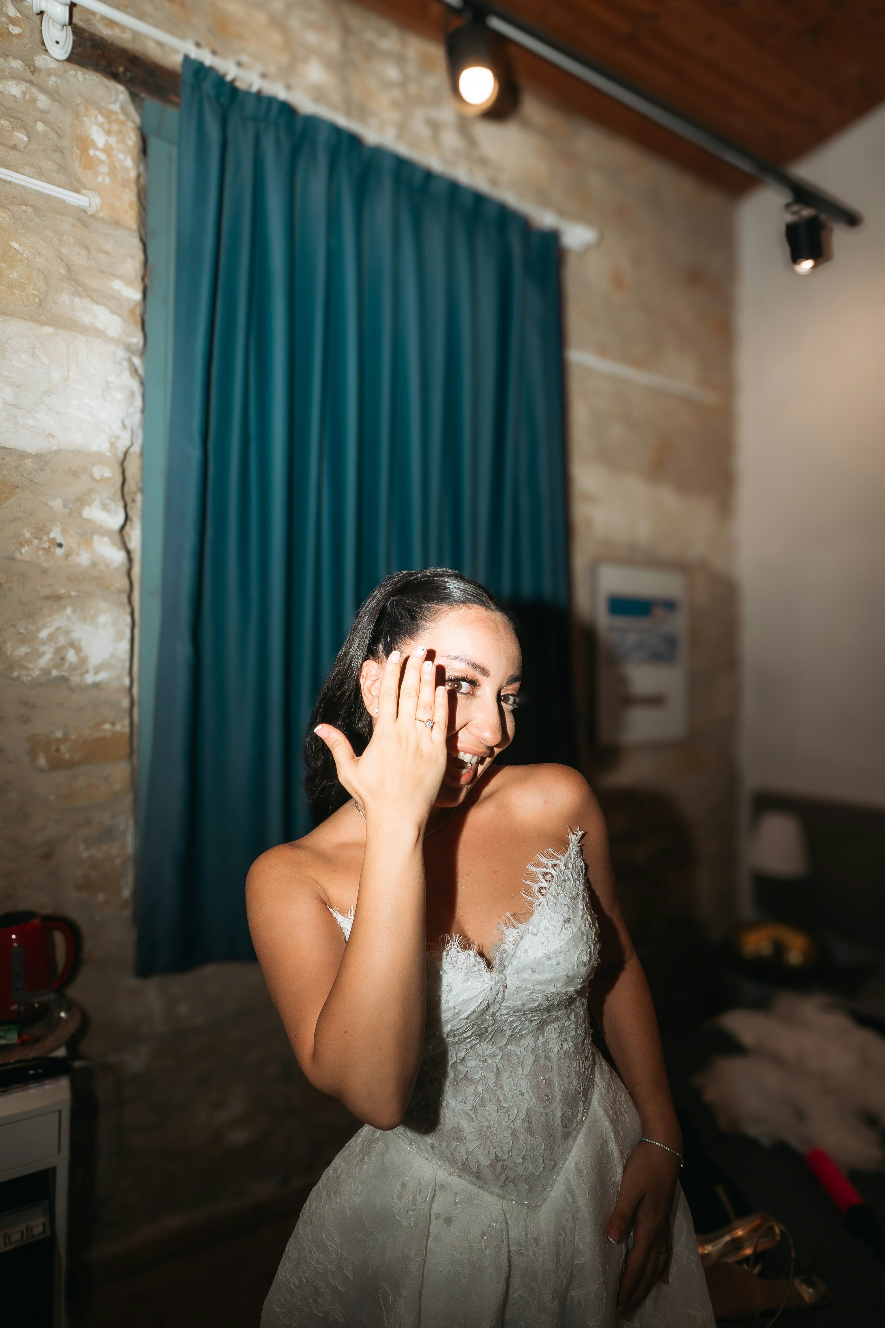 Bride in Lace: A Playful Moment Under Ambient Studio Light