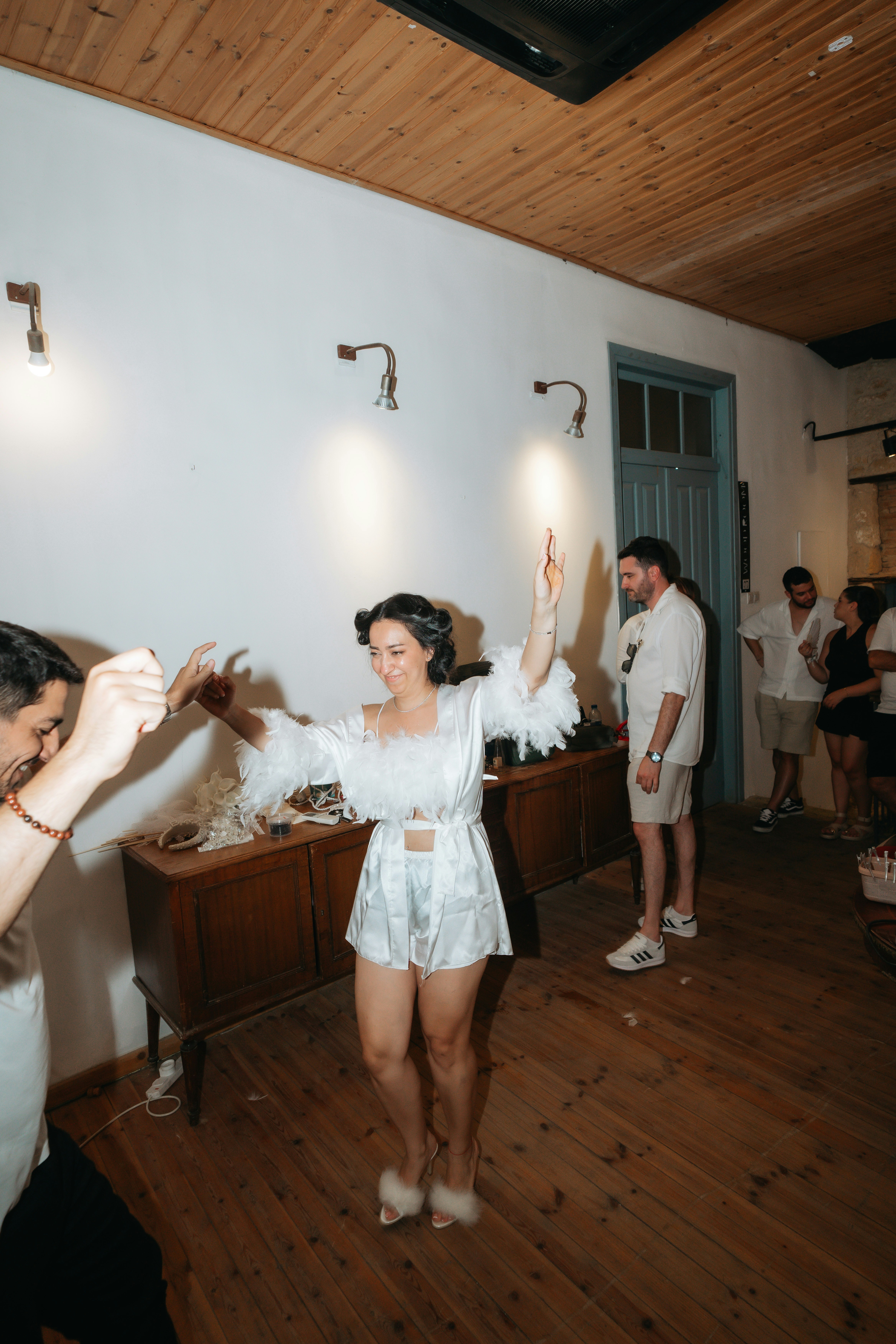 Feathered Celebration: a dancer mid-gesture in a sunlit rustic hall