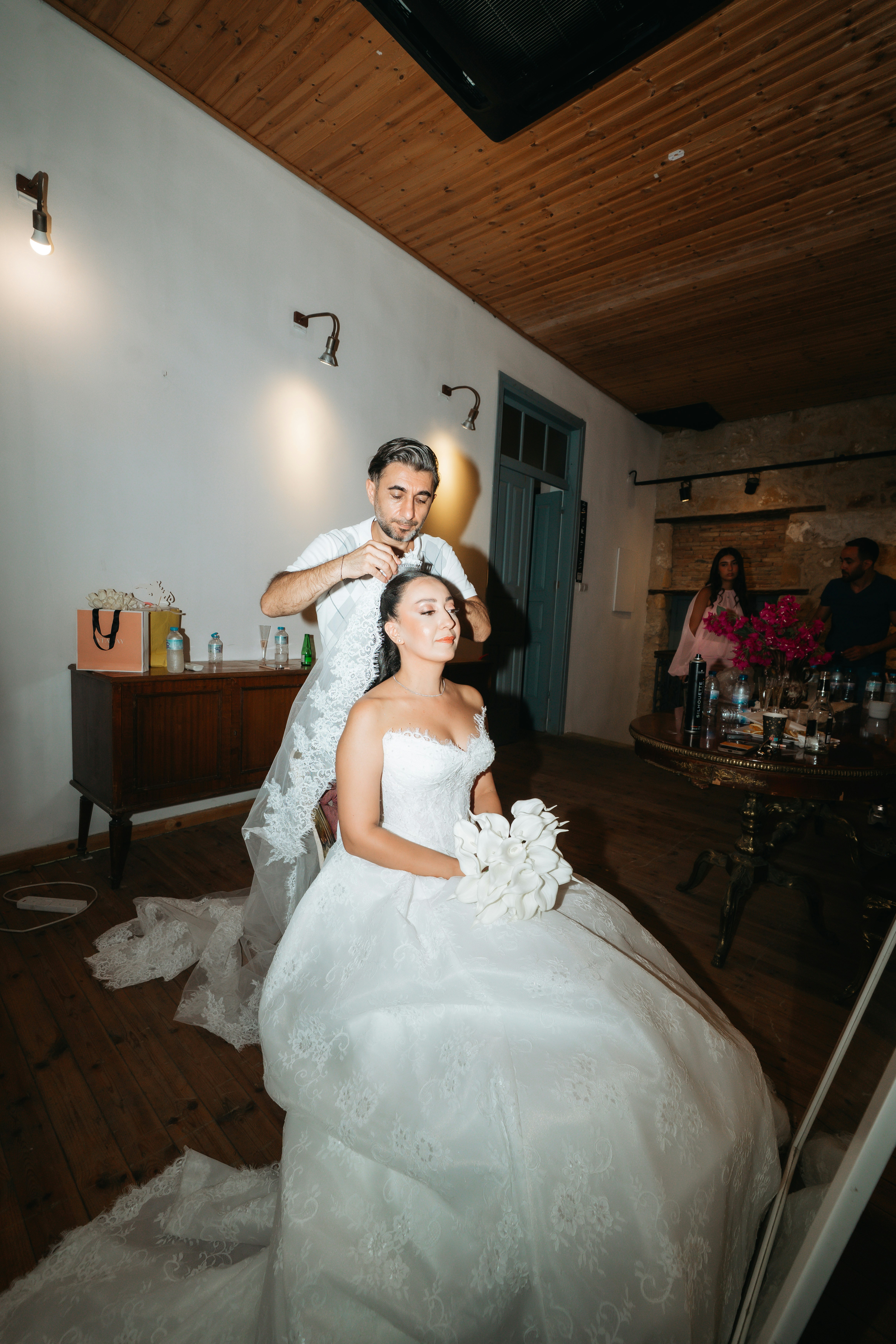 Bride in White: A Quiet Moment of Hands and Veil at a Winery Reception
