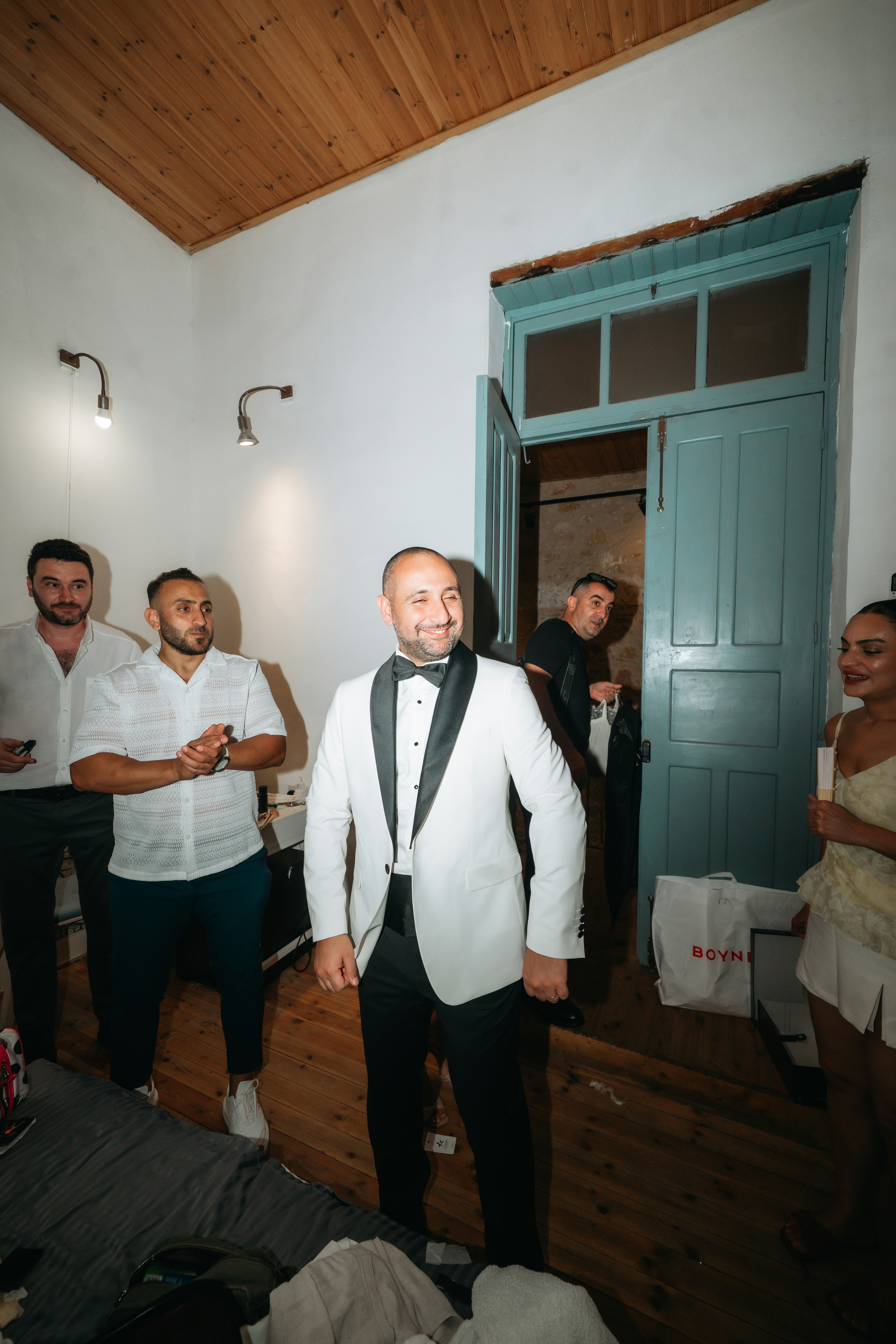 Gentlemen’s Entrance: A Groom’s Moment in a Sunlit Room
