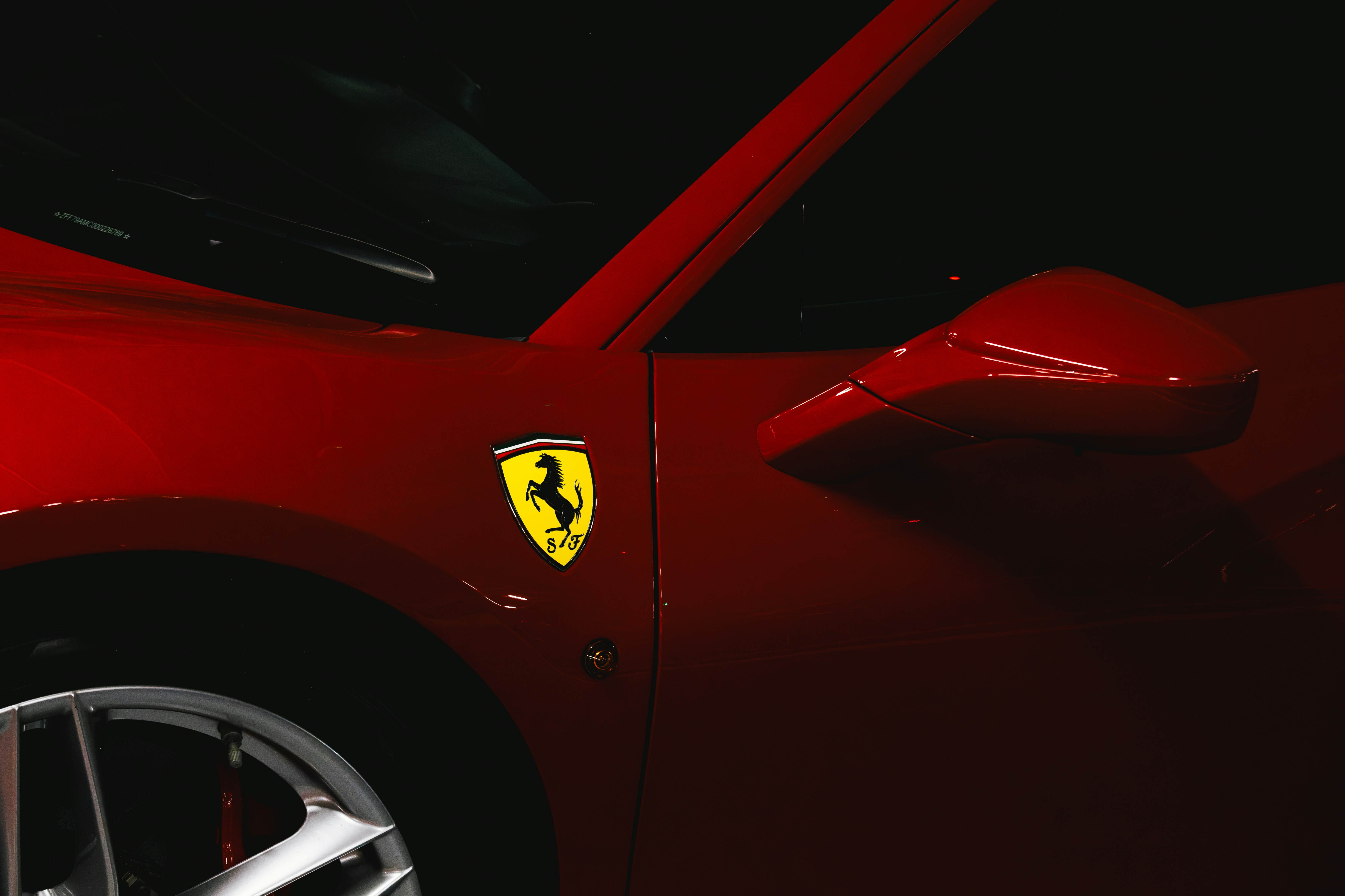 Scarlet Silhouette: The Ferrari Emblem and Curves at Night