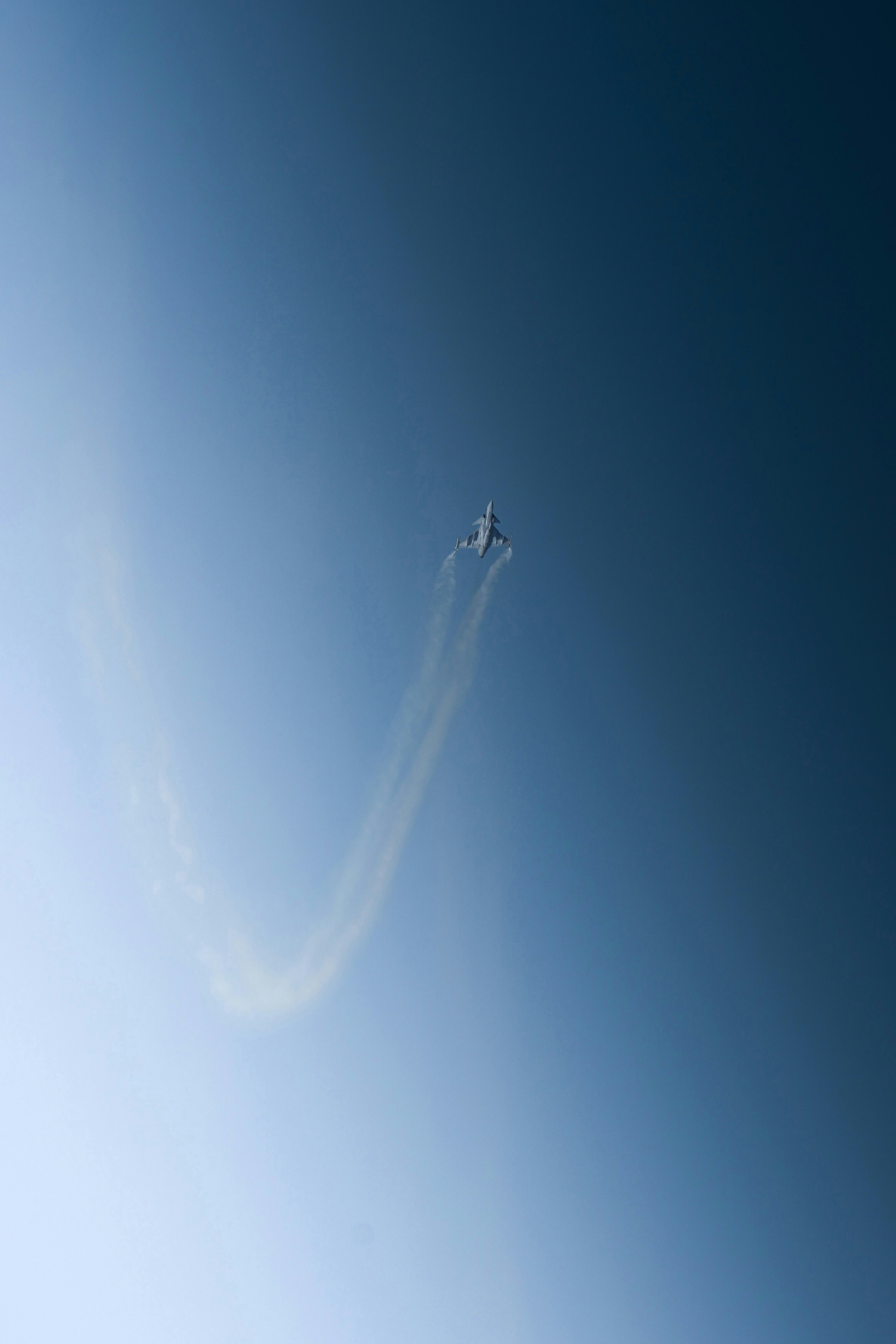 Jet Trail Arc Across a Cerulean Sky