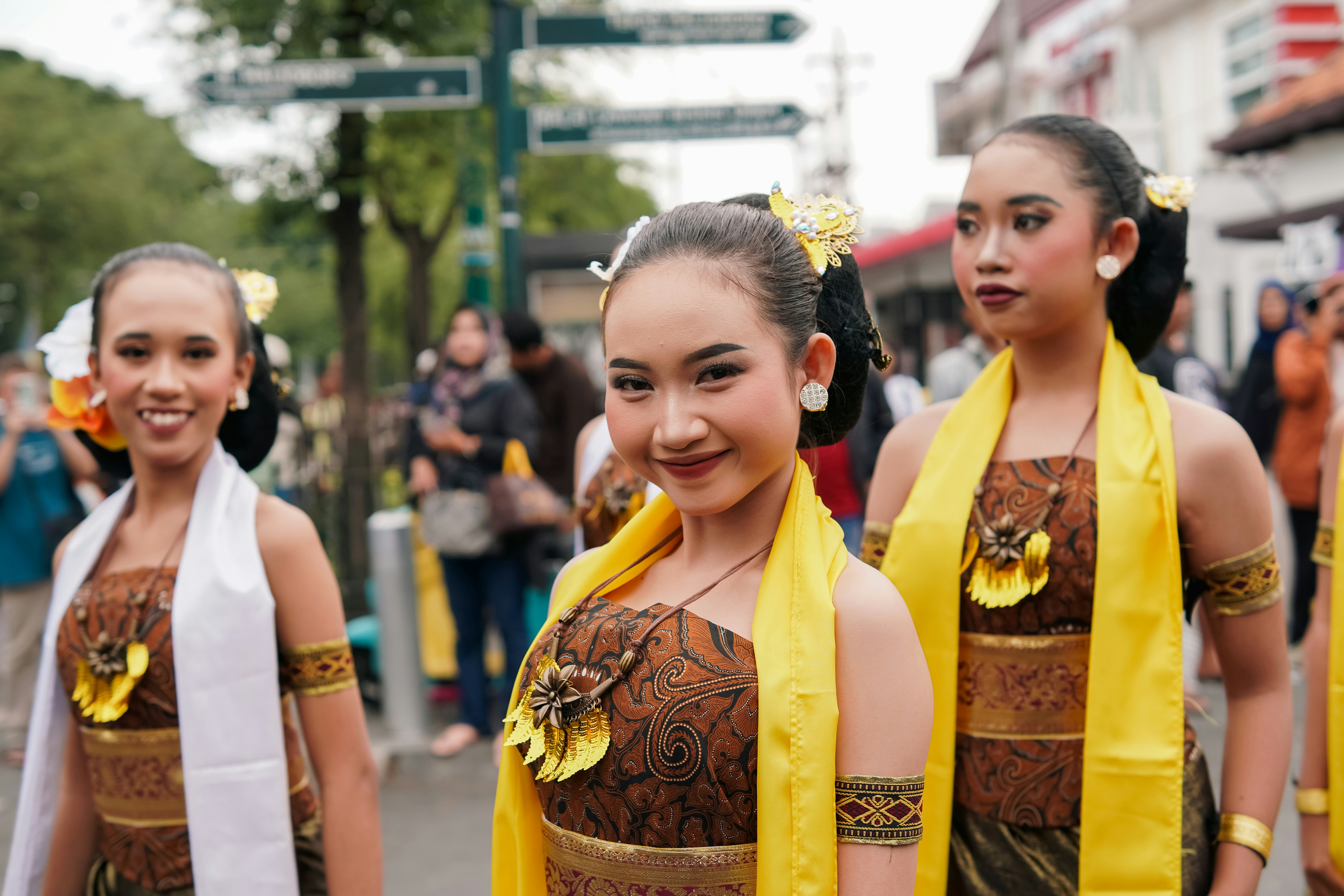 Central Performer in Festive Street Dance with Bright Yellow Sashes