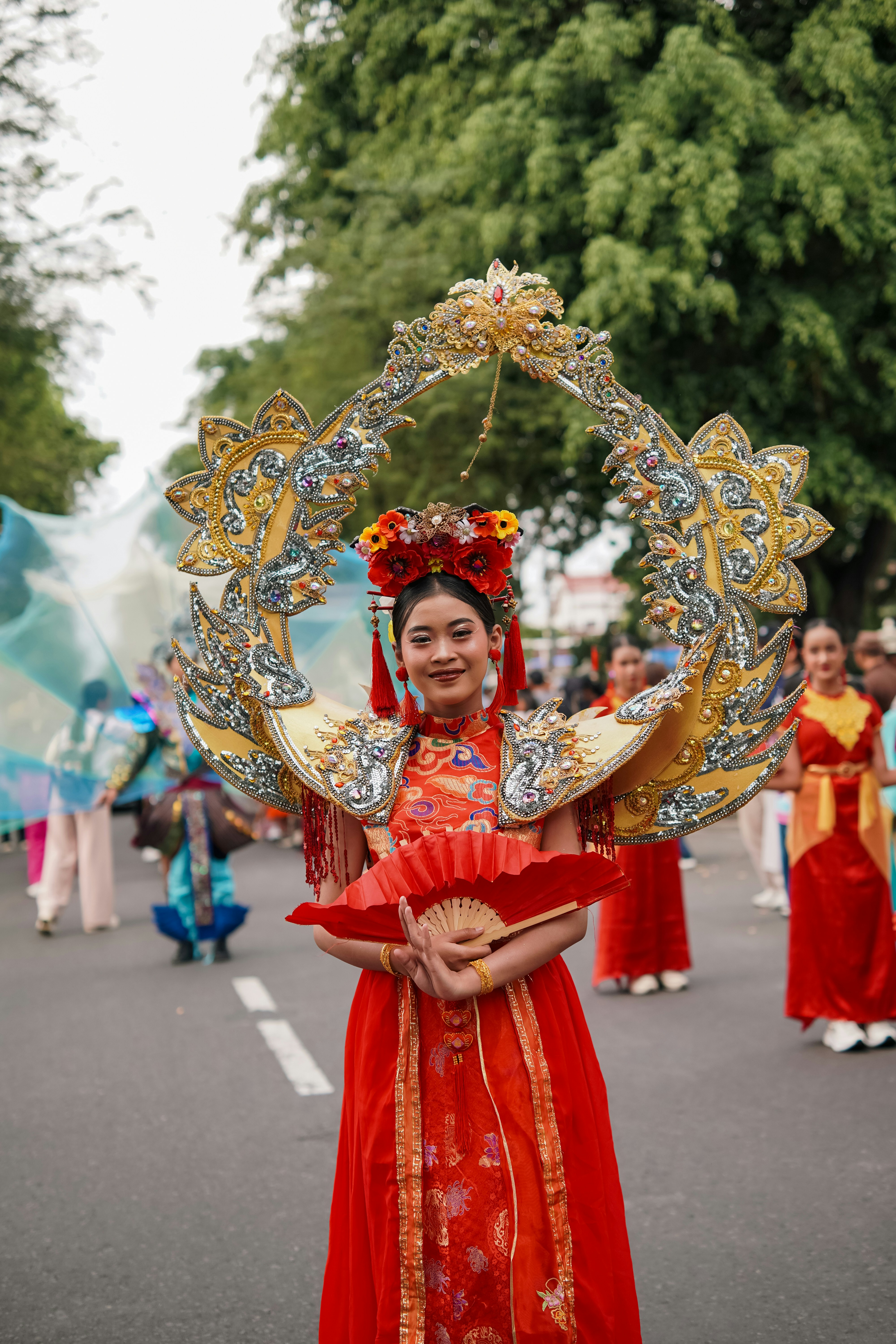 Regal Dancer with Ornate Crescent Headdress in a Street Parade