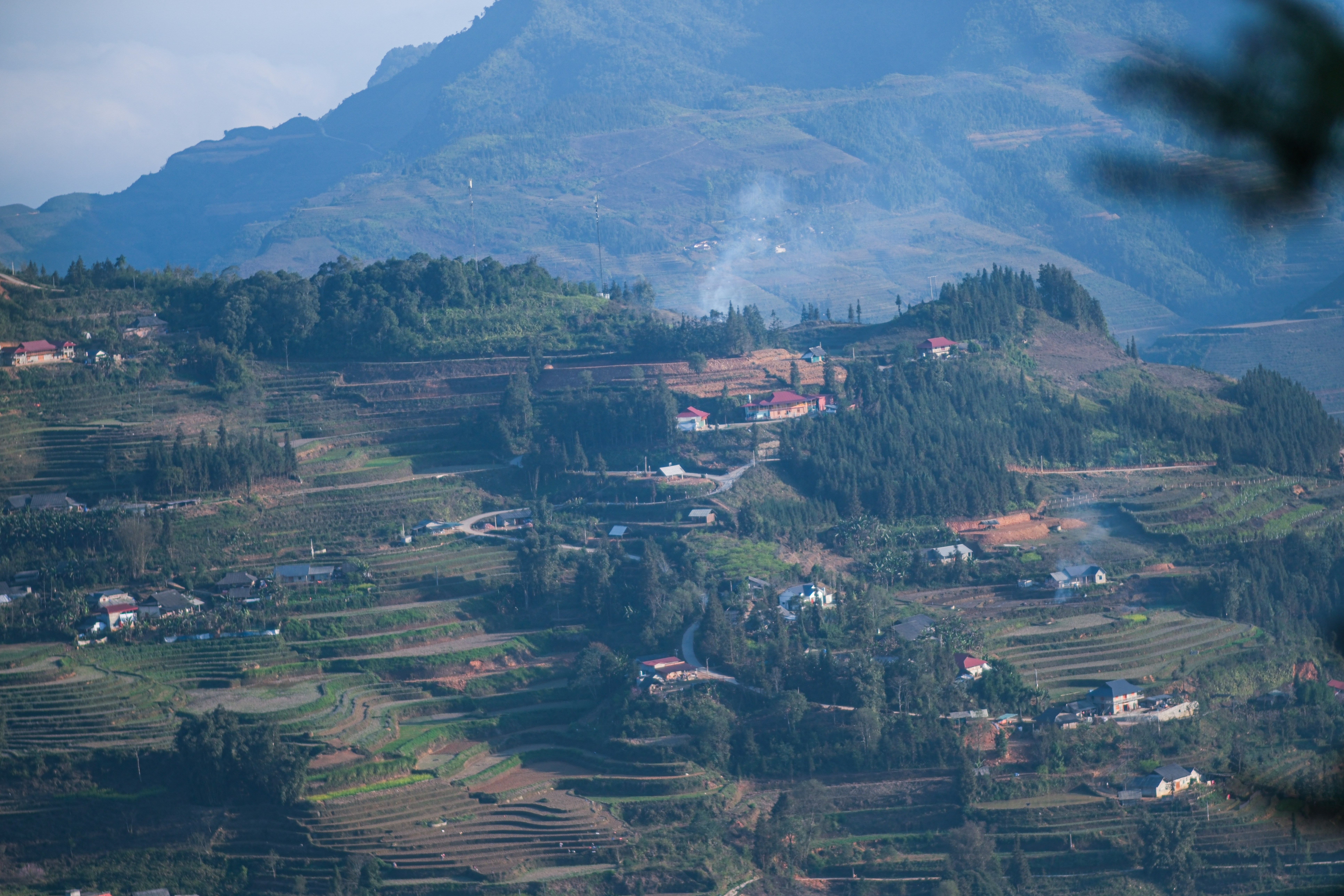 Terraced Hillside Villages Under a Misty Mountain Veil
