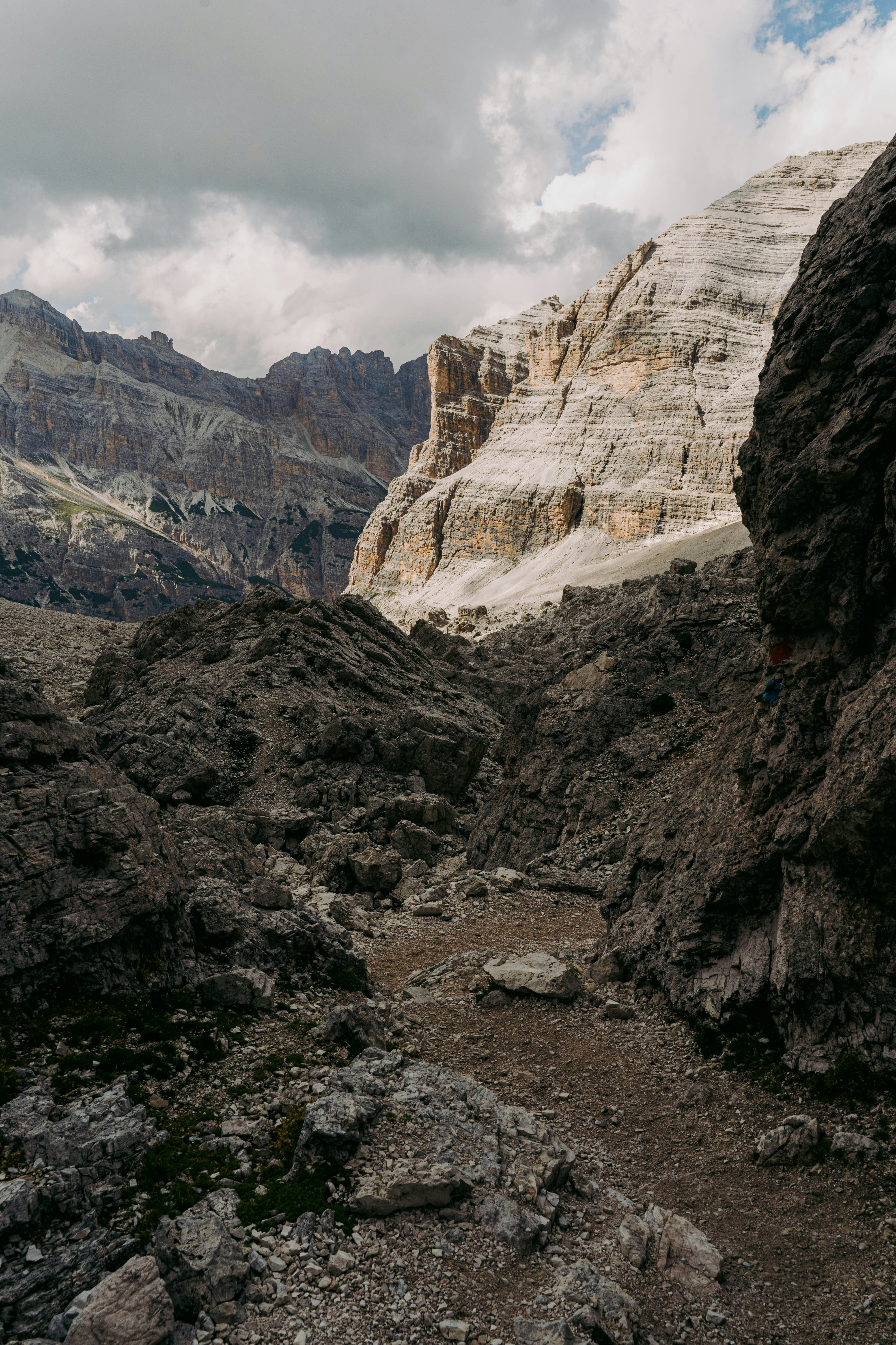 Rugged Ascent: A Narrow Path Through Stone Walls Beneath Weathered Cliffs