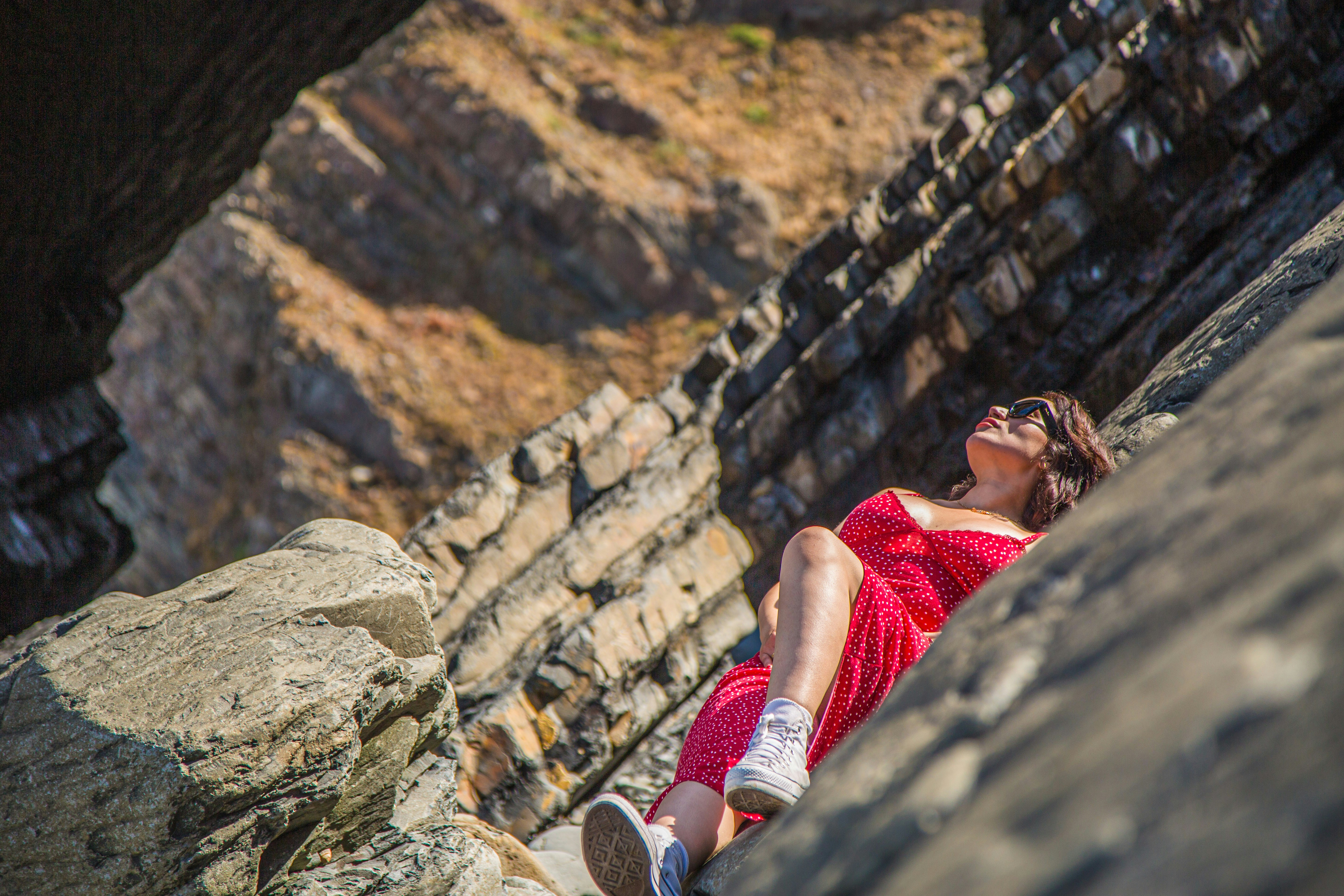 Sunlit Red Dress on a Quiet Cliff Edge