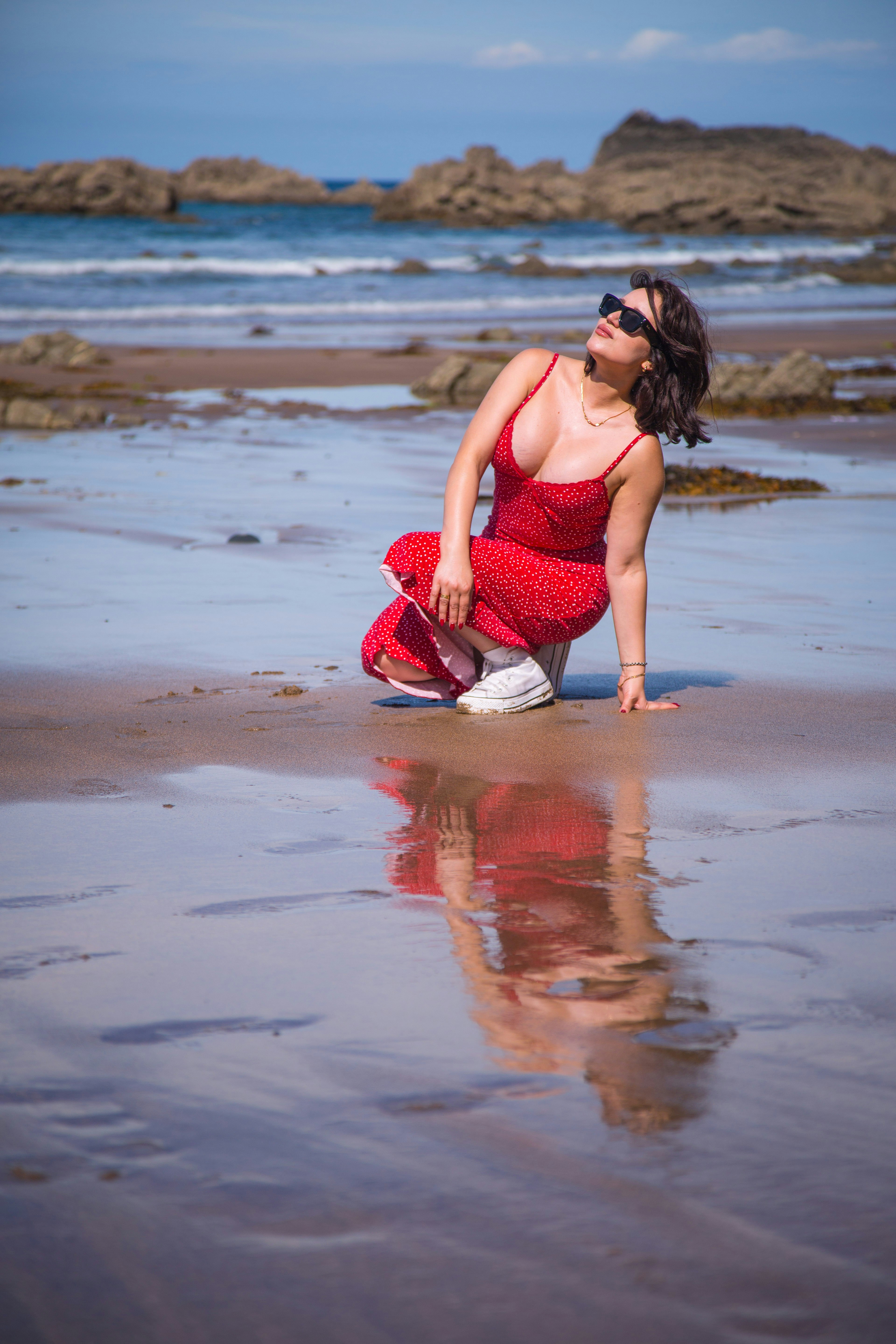 Red Dress on the Wet Sand: A Beach Portrait with Reflective Quiet