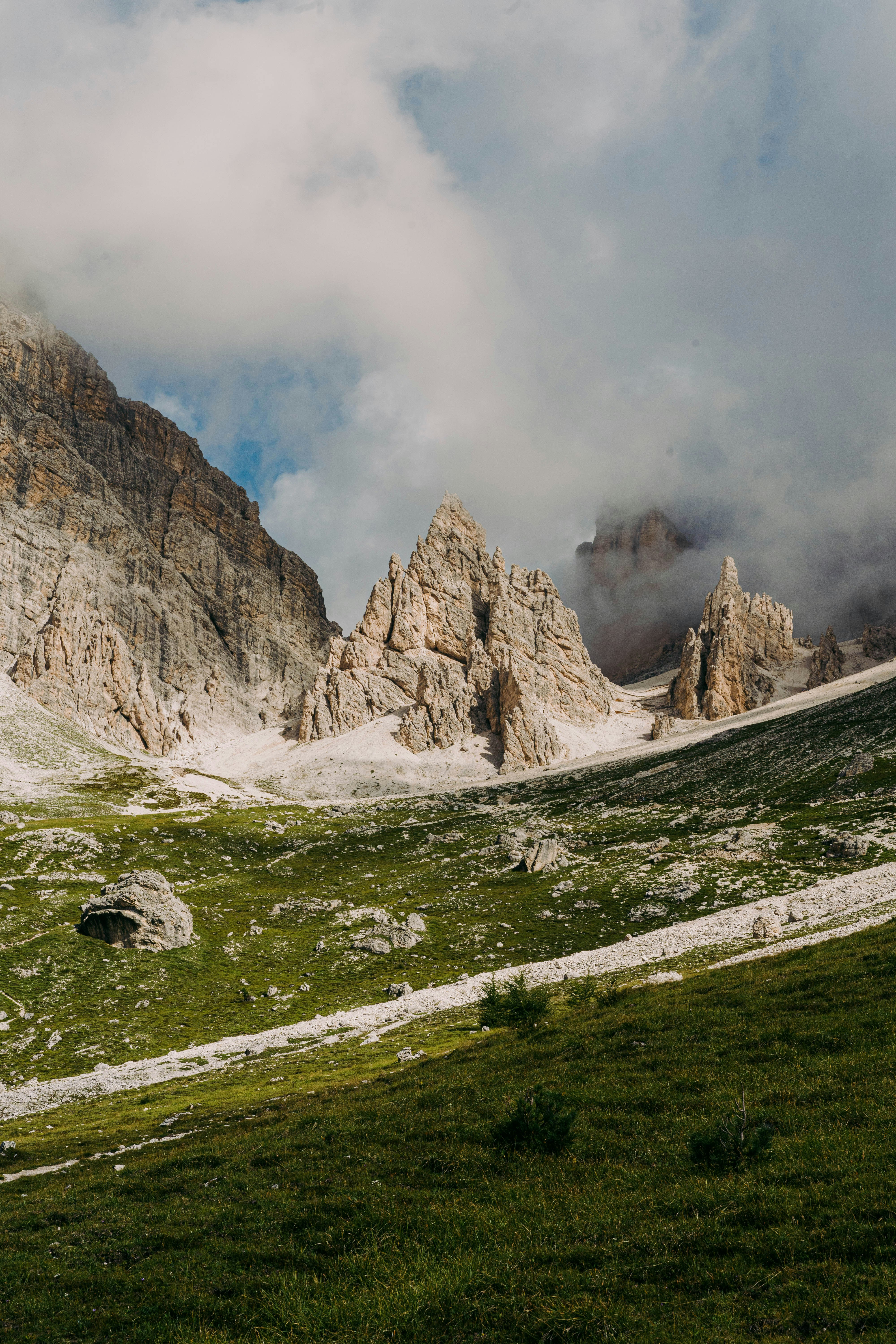 Rugged Dolomite Peaks Veiled by Clouds
