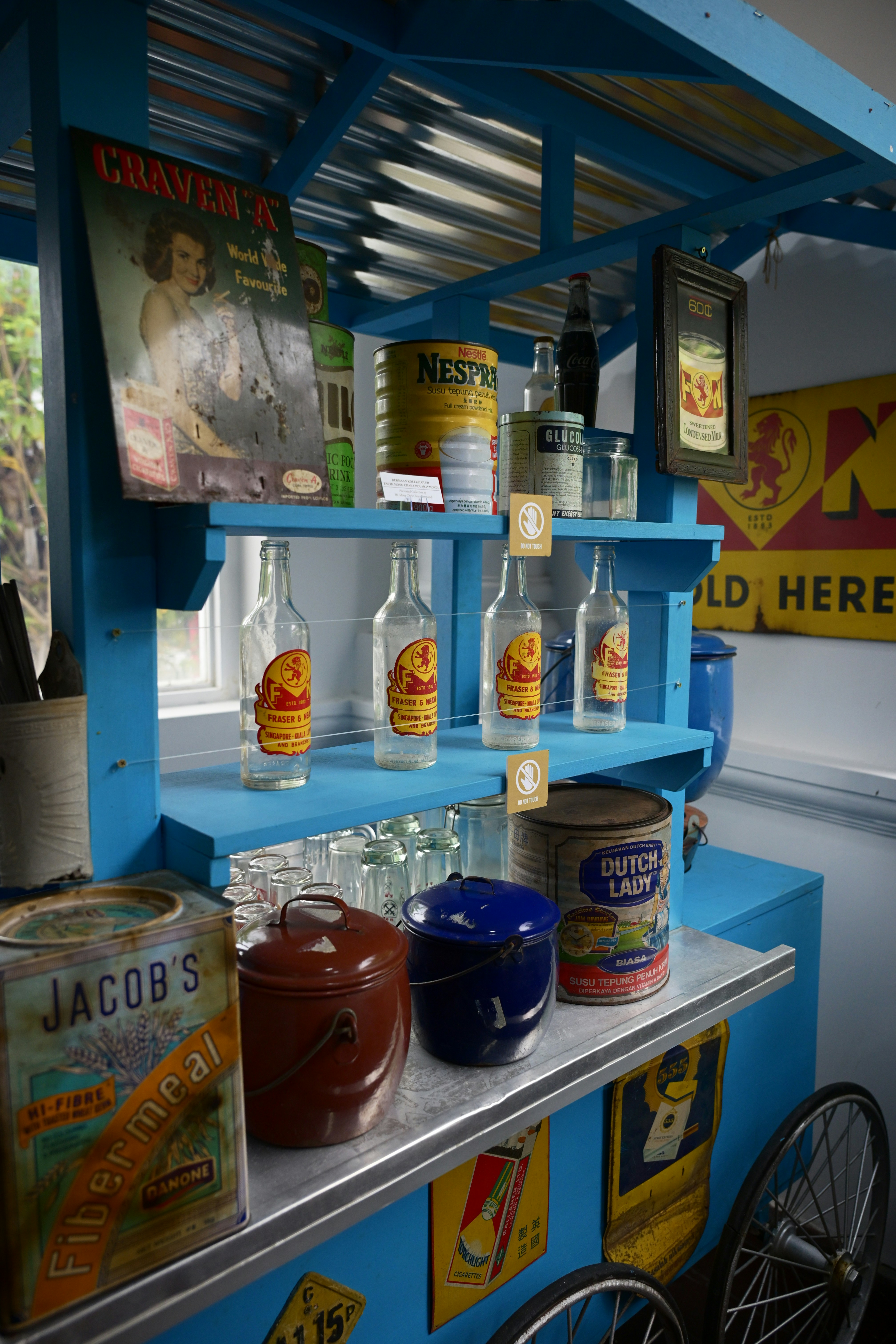 Blue Vintage Snack Bar: Glass Bottles and Tin Cans on a Sunny Counter