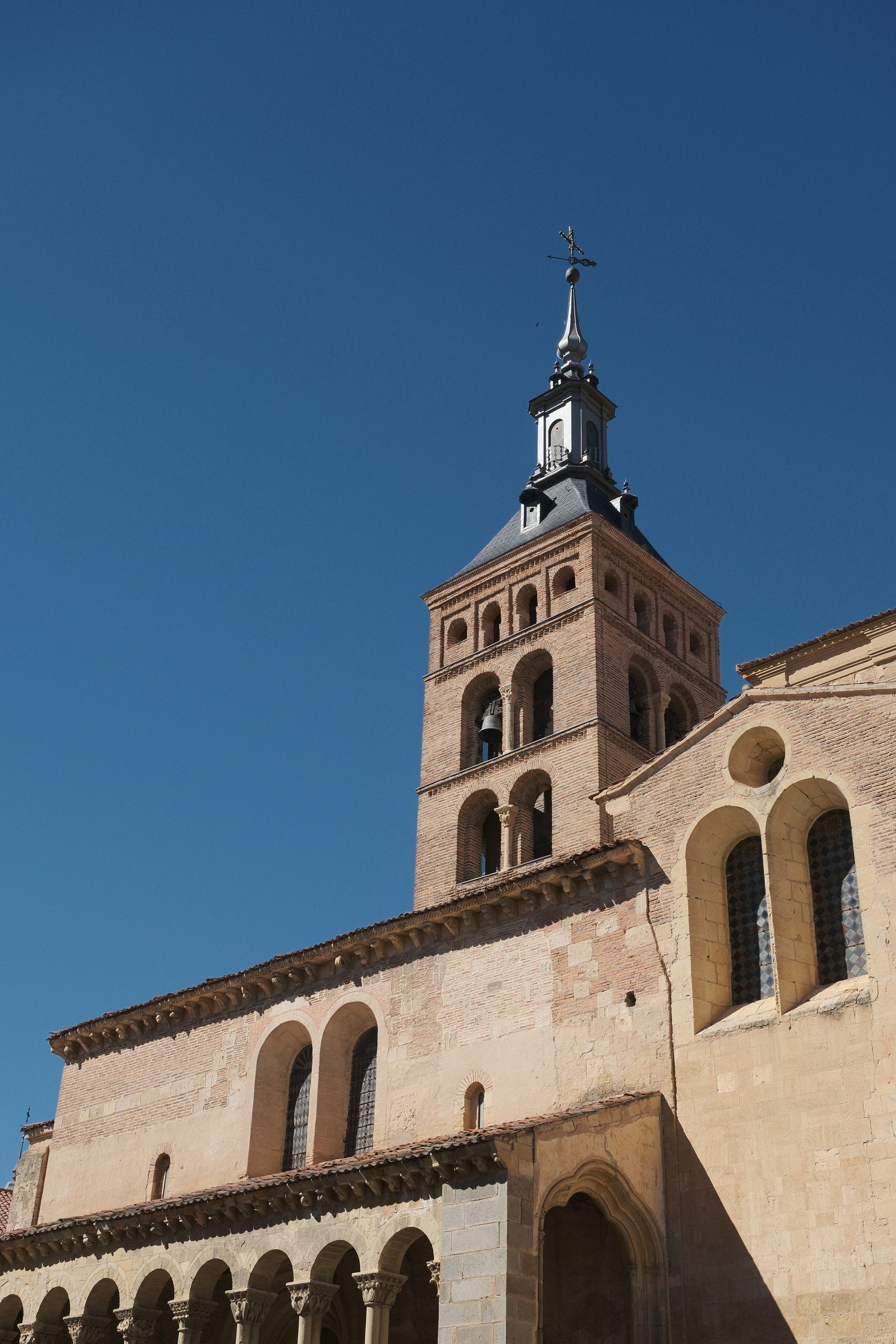 Towering Brick Bell-Tower Against a Clear Blue Sky
