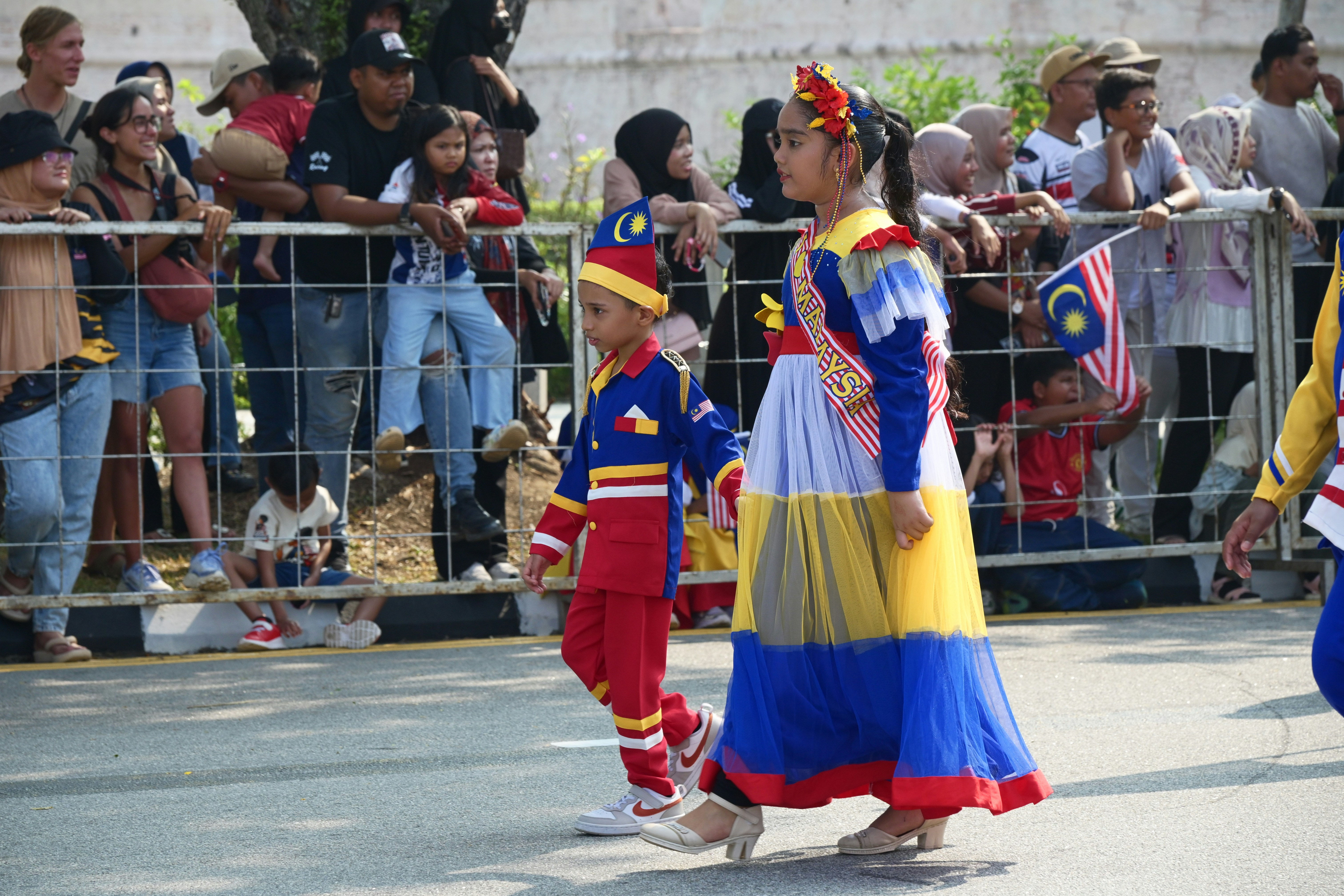 Colorful Parade of Miniature Royals Walks Beside the Barrier