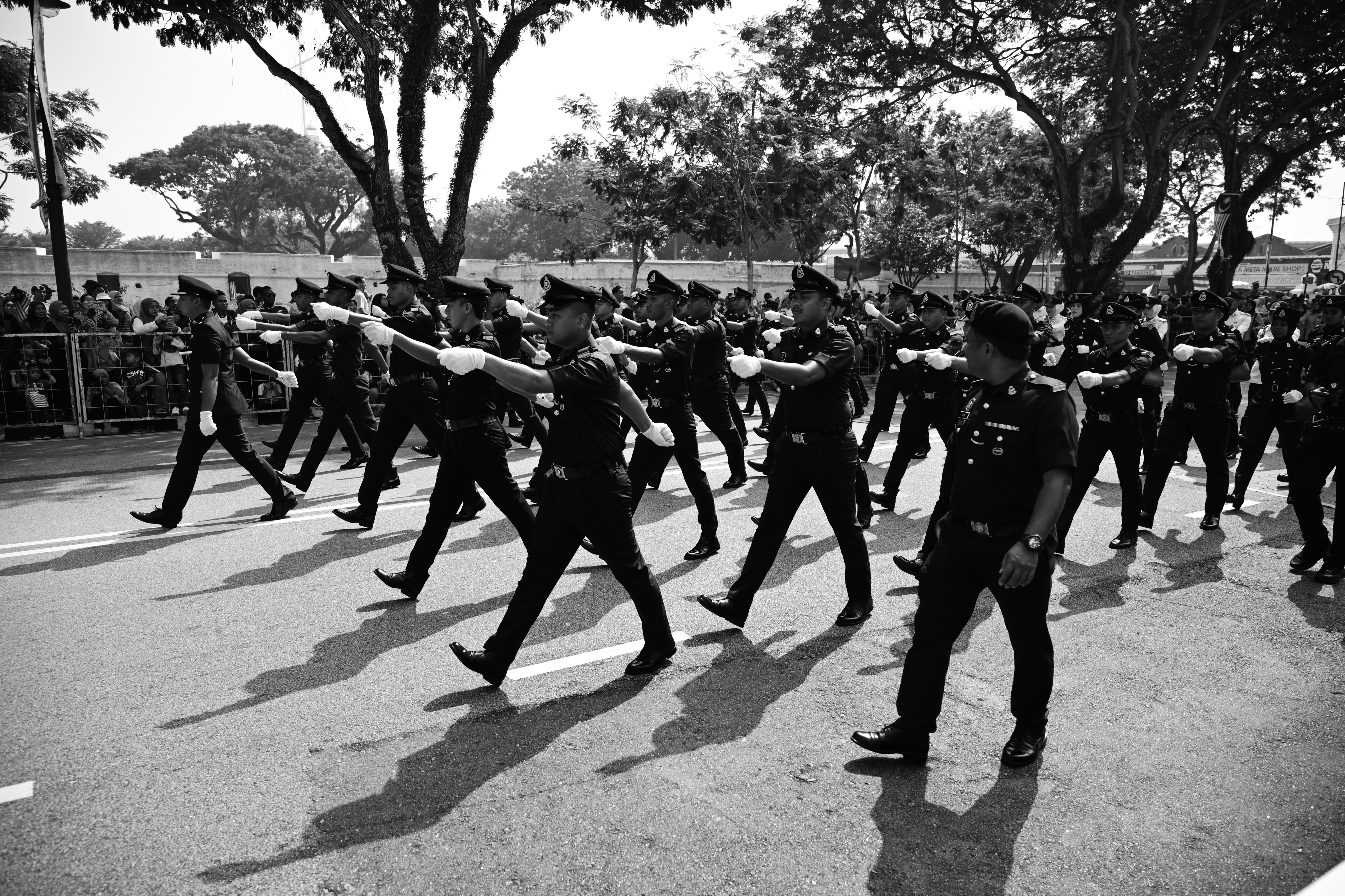Marching Line: Uniformed Cadets Move in Lockstep Across an Open Street