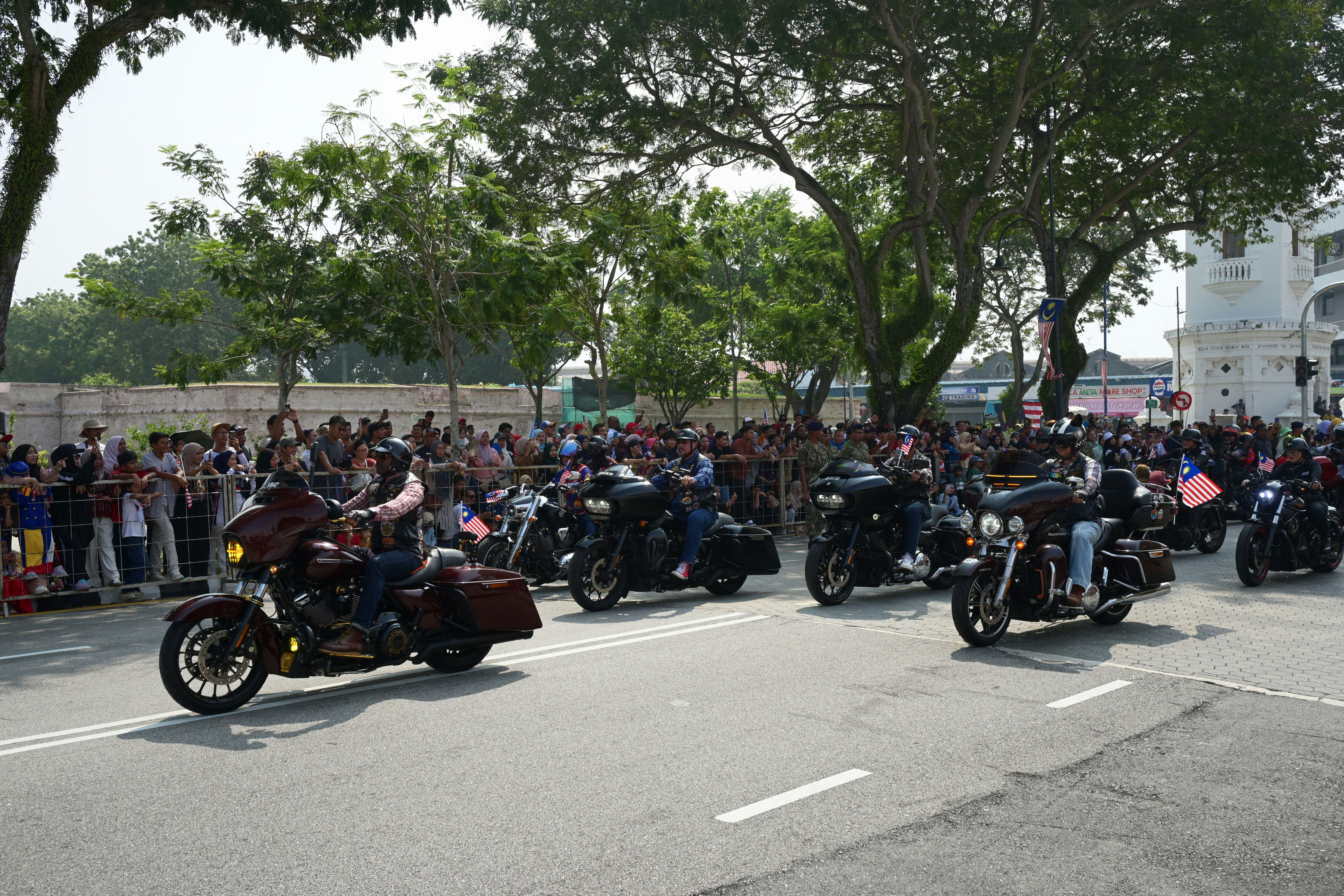 Line of Steel: Motorcycles and Crowd under Shade